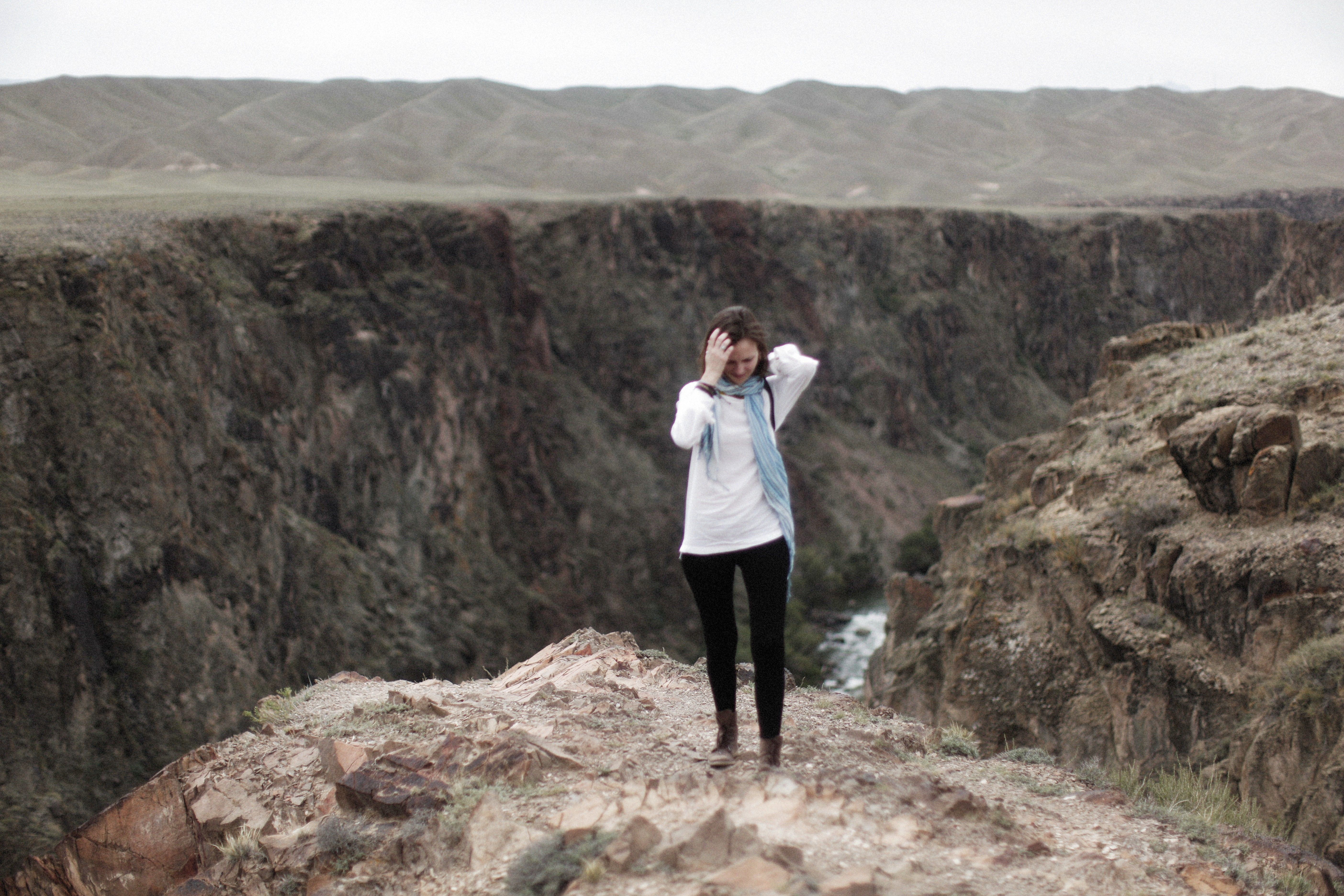 Woman Standing on a Plateau · Free Stock Photo