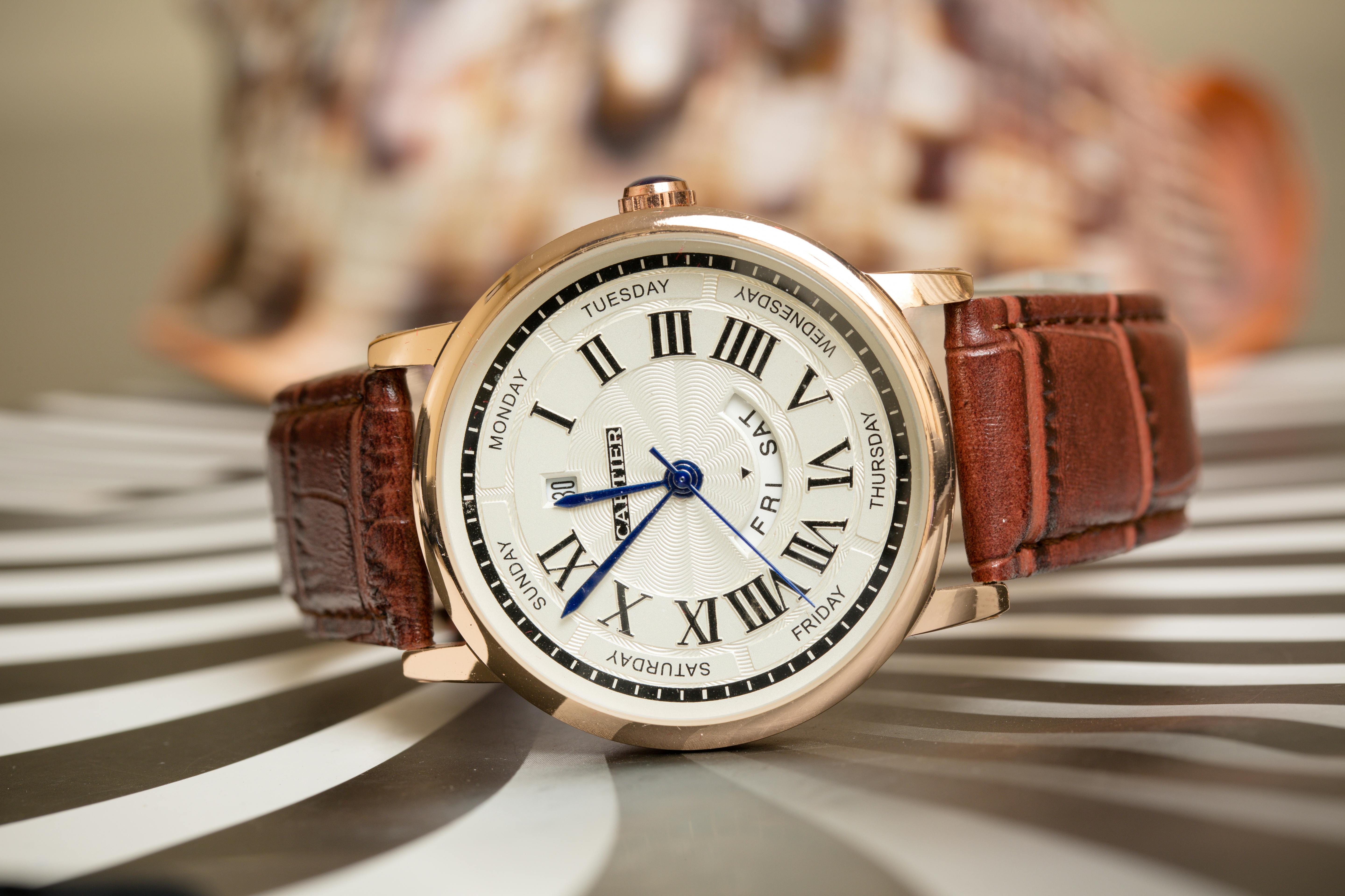 Analog Watch Beside A Comb · Free Stock Photo