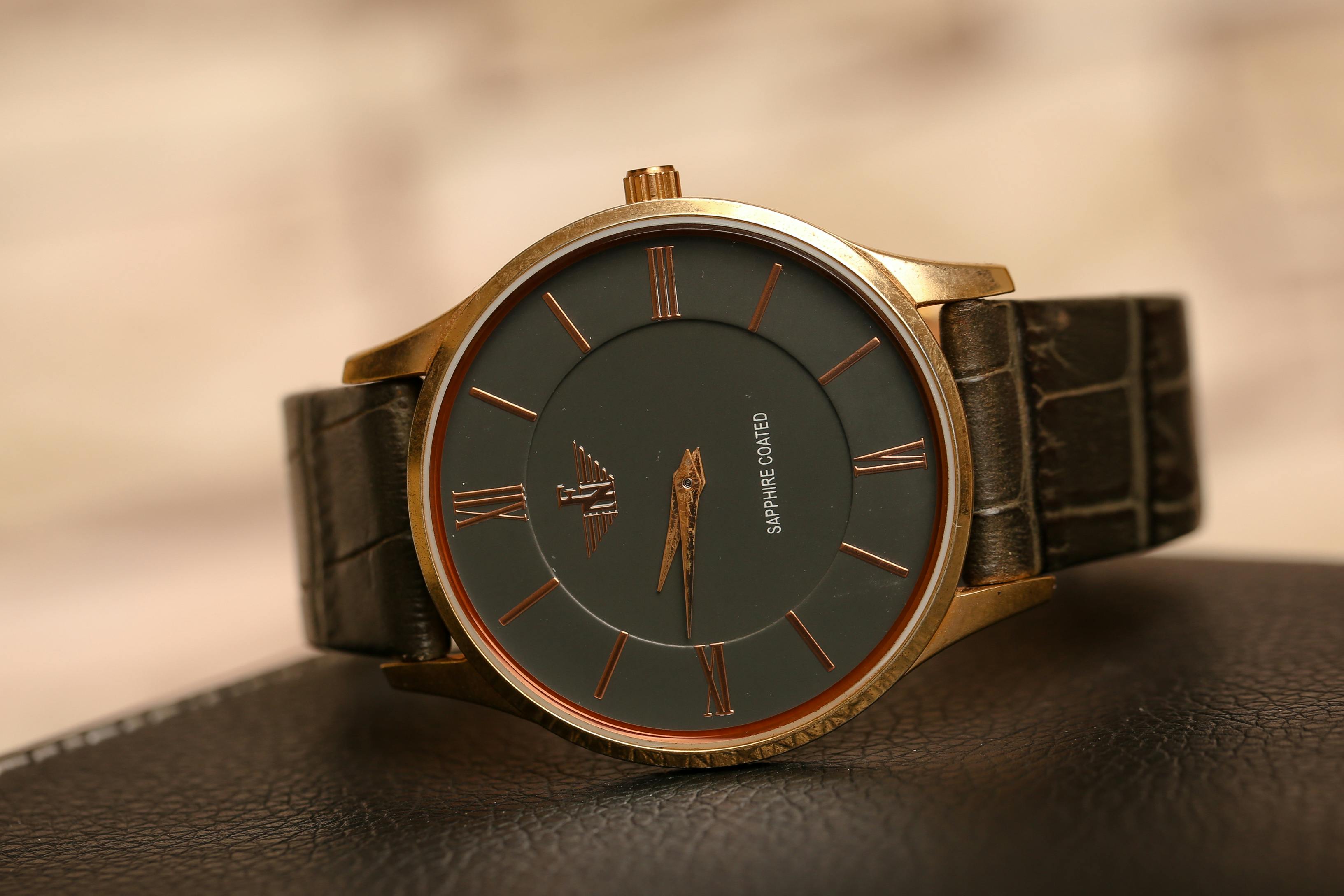 Analog Watch Beside A Comb · Free Stock Photo