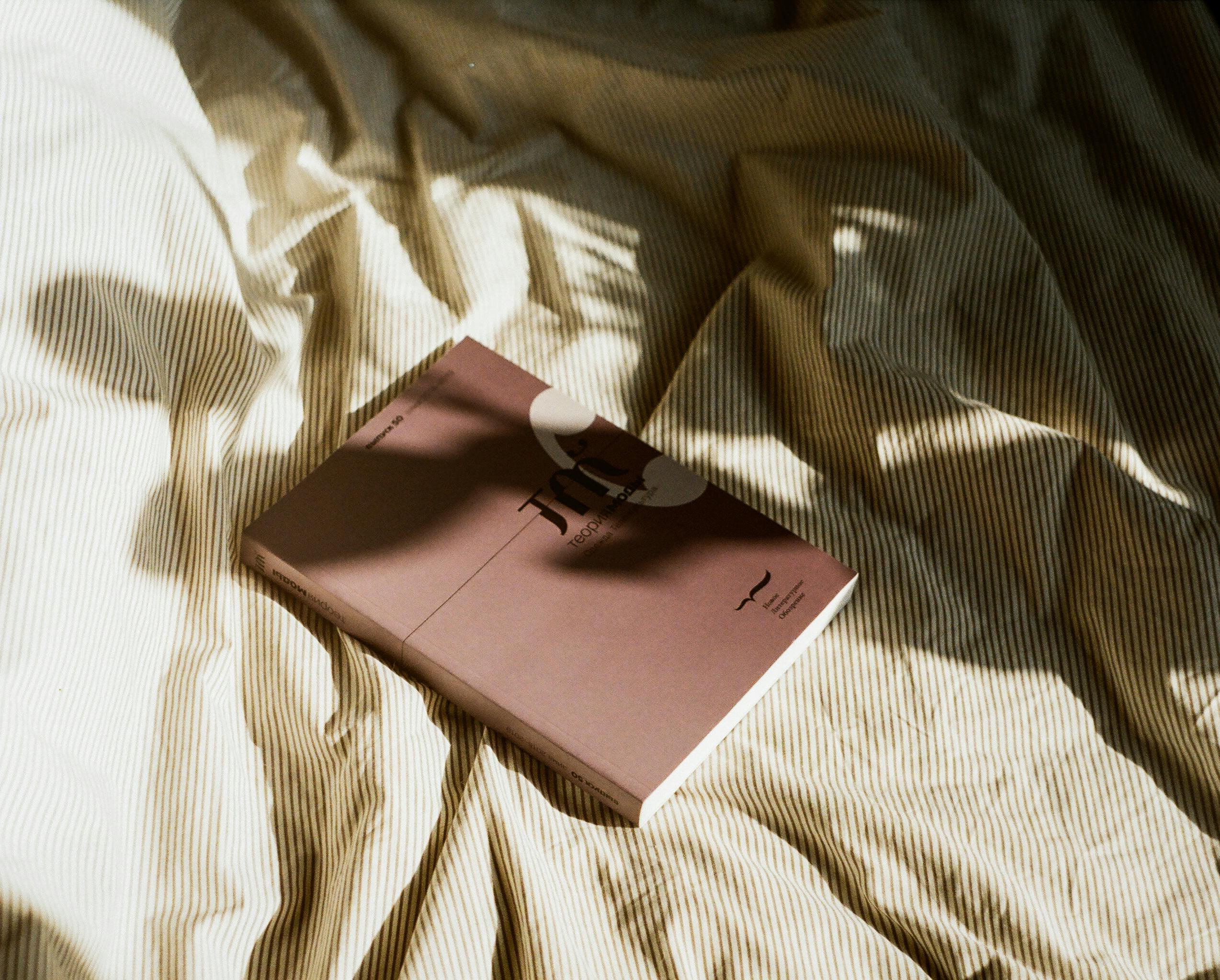 Top View of a Book on the Bed · Free Stock Photo