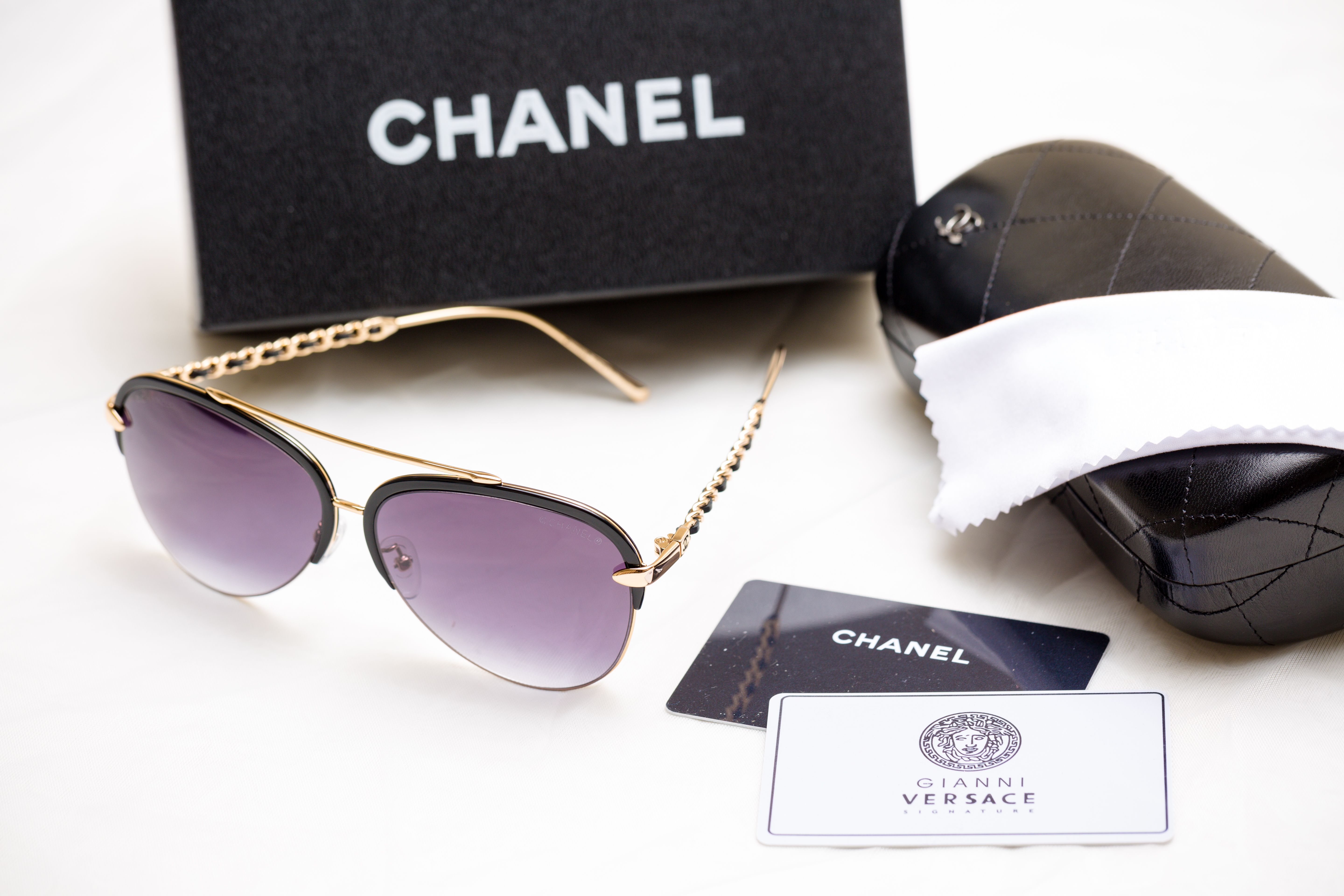 Red Framed Sunglasses Beside the Photographs · Free Stock Photo
