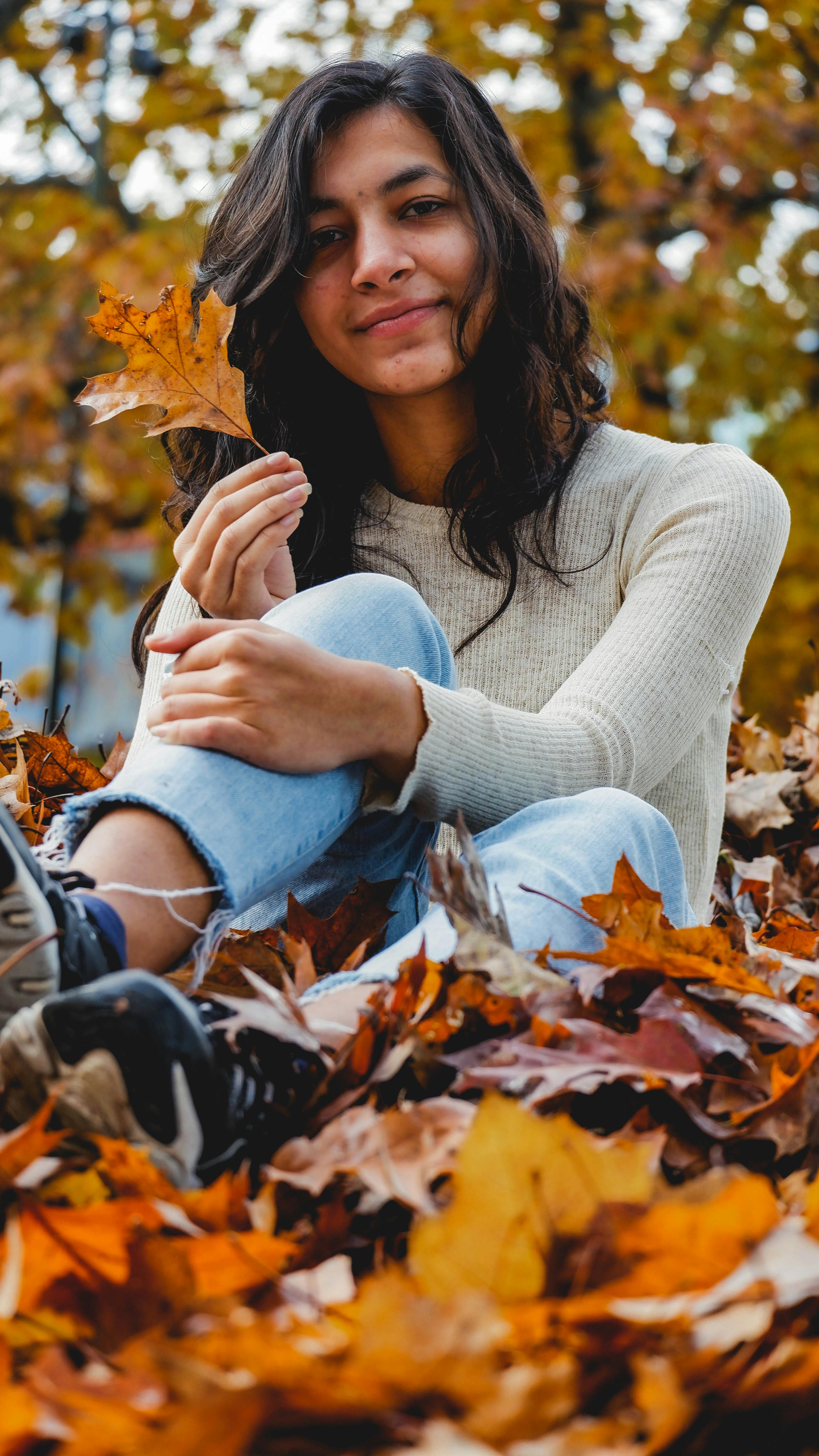 A Woman Catching Falling Leaves · Free Stock Photo