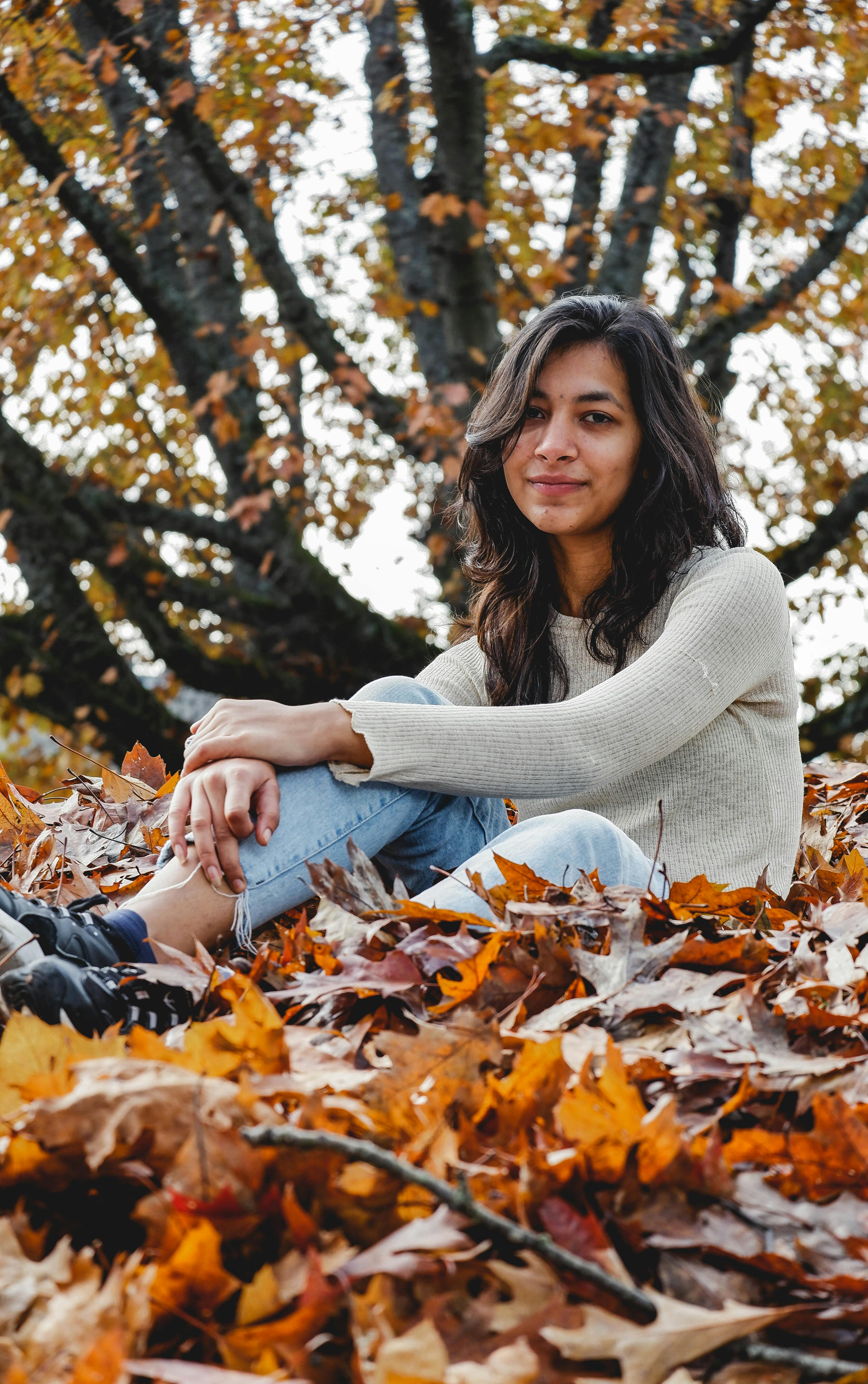 A Woman Catching Falling Leaves · Free Stock Photo