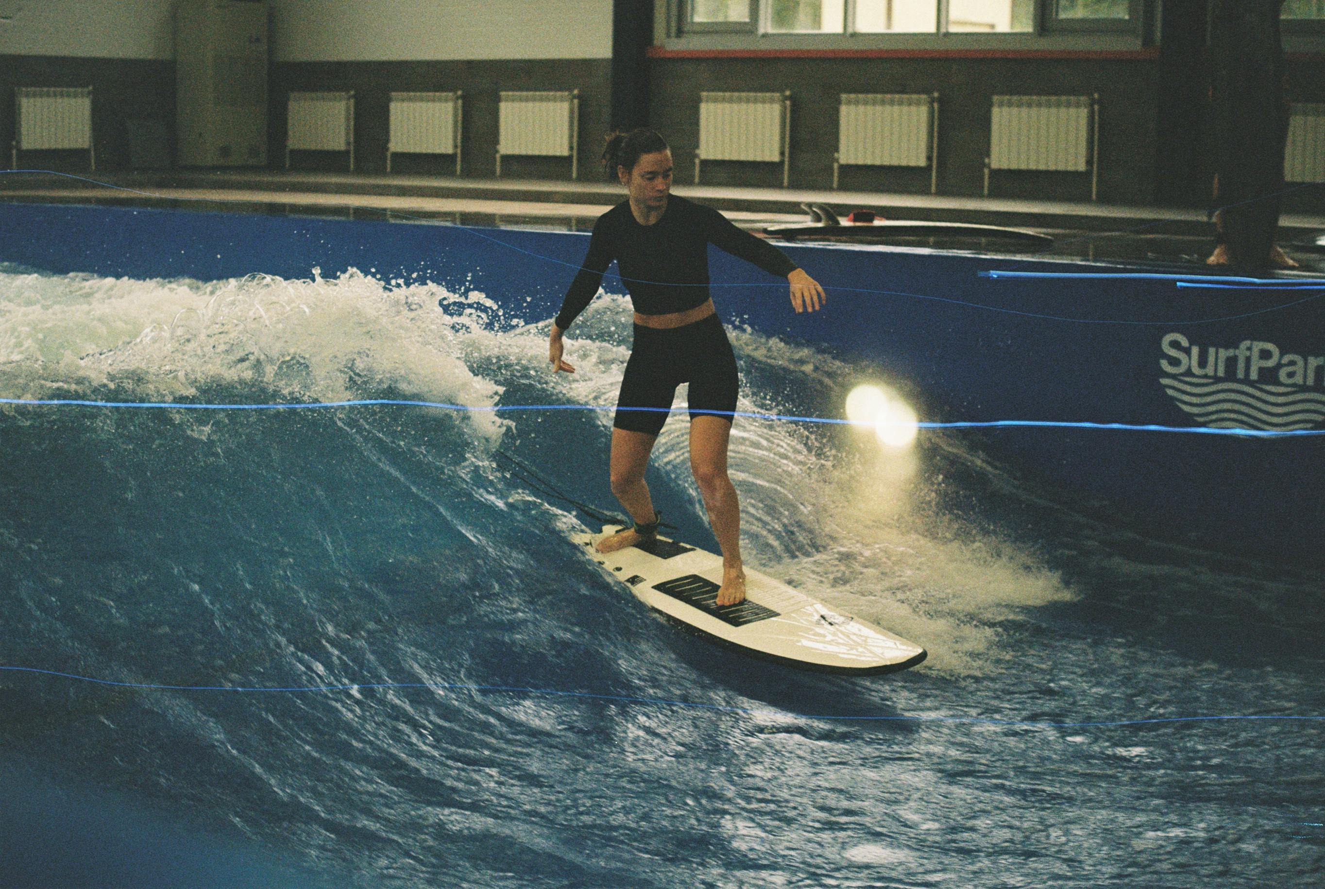 Woman in Black Rash Guard Riding Surfboard · Free Stock Photo