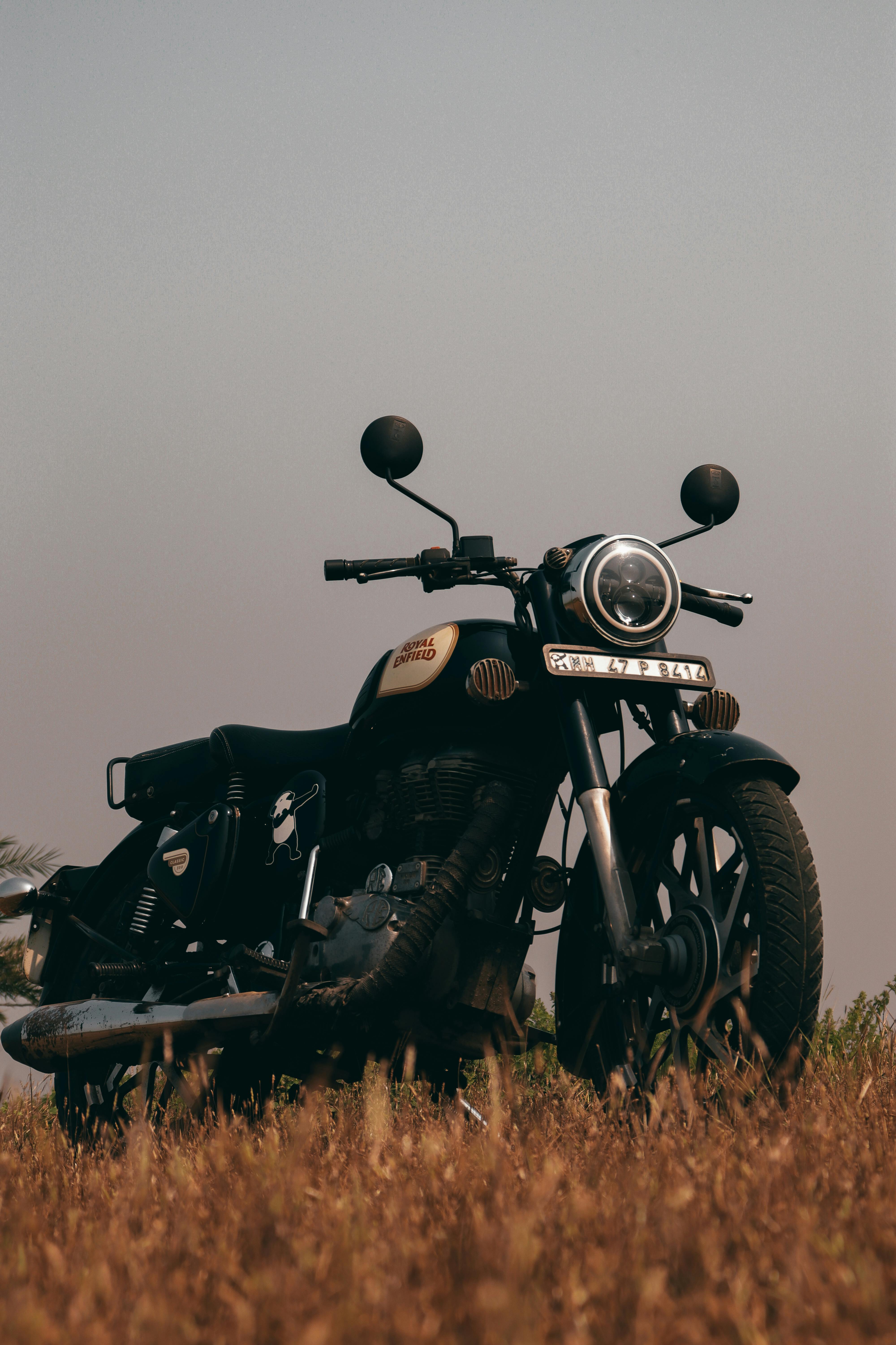 A Motorcycle Parked on a Grassland · Free Stock Photo