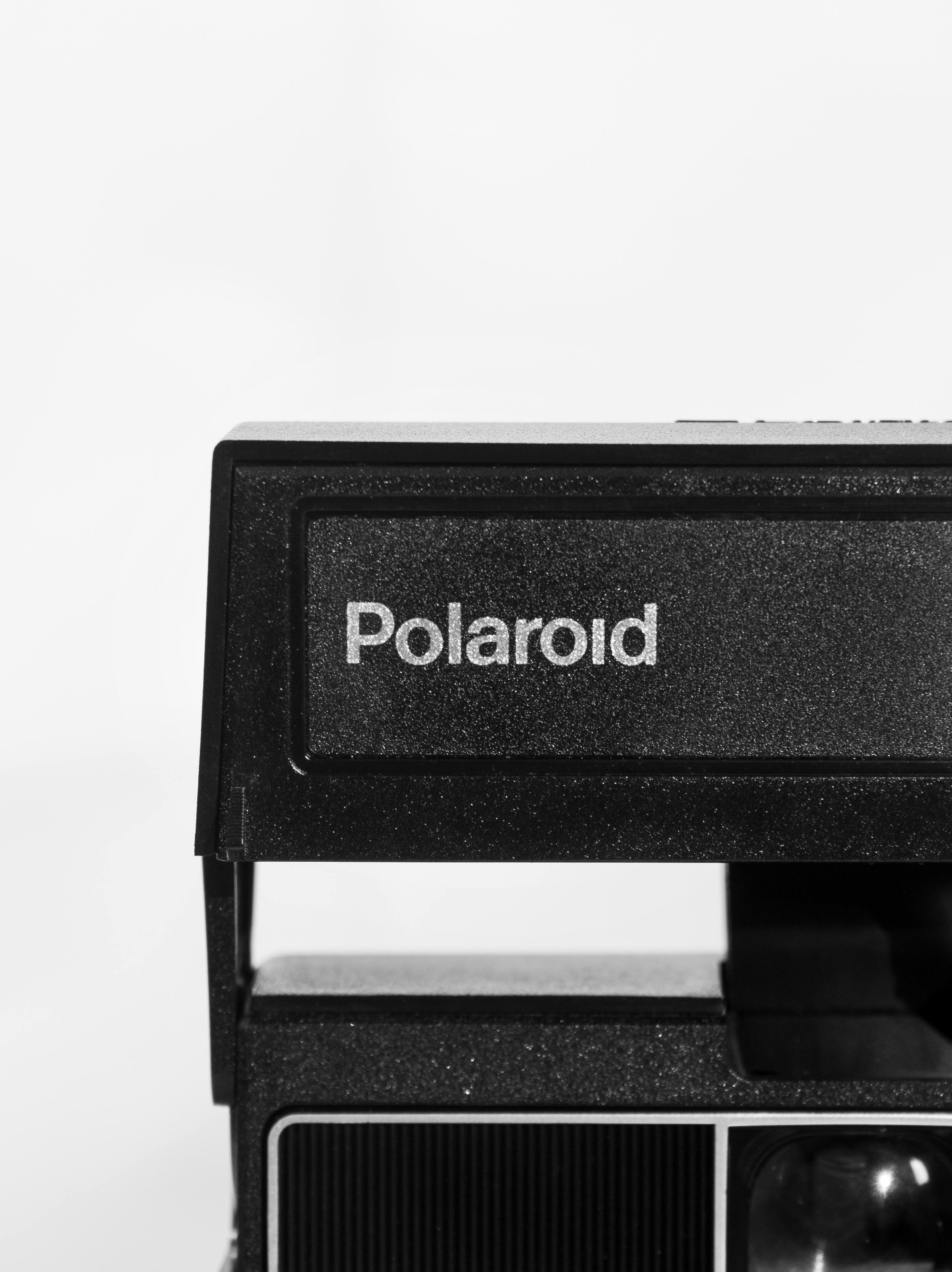 Photo of Polaroid Camera Near Book · Free Stock Photo