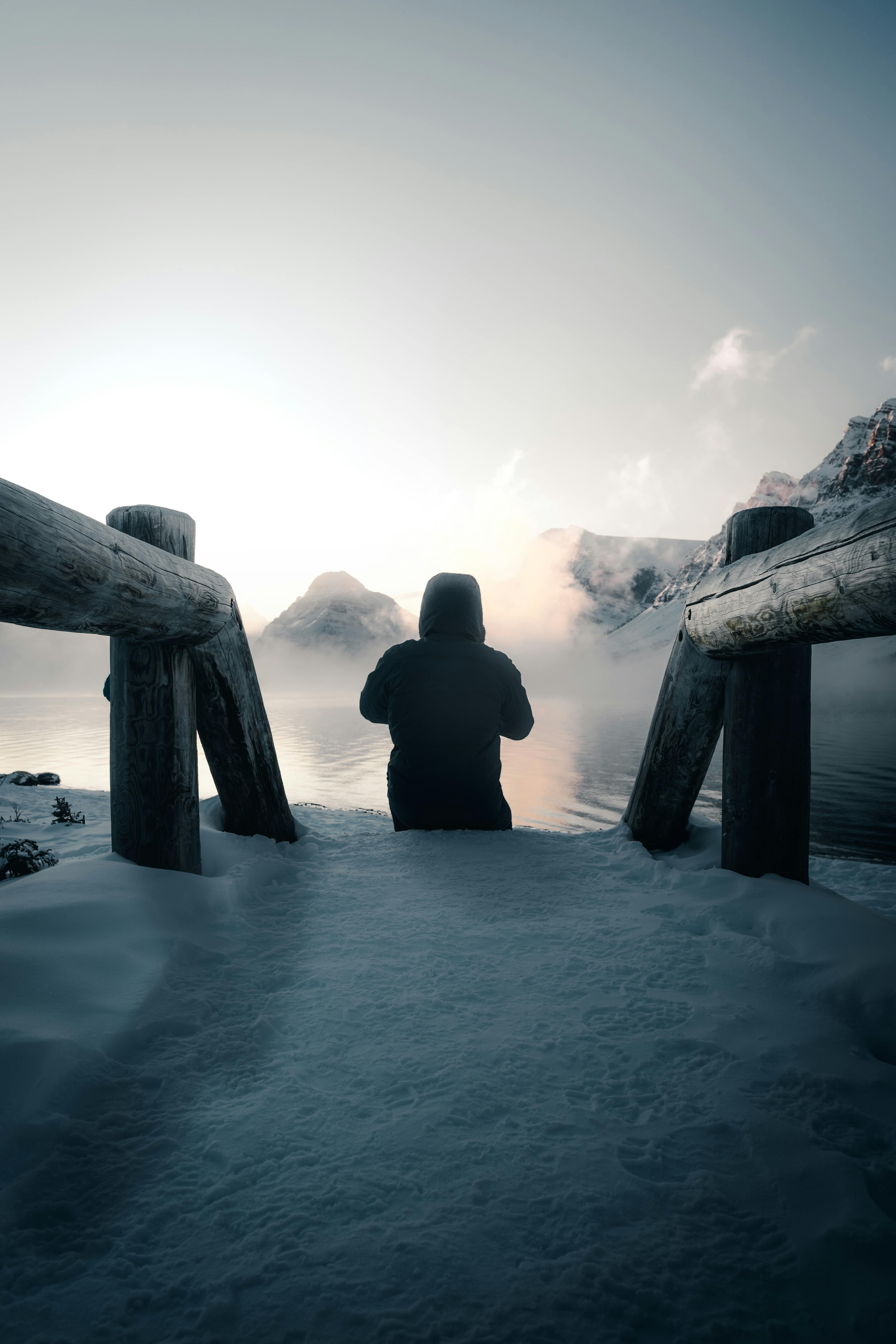 Man Sitting on Steps Beside Lake · Free Stock Photo