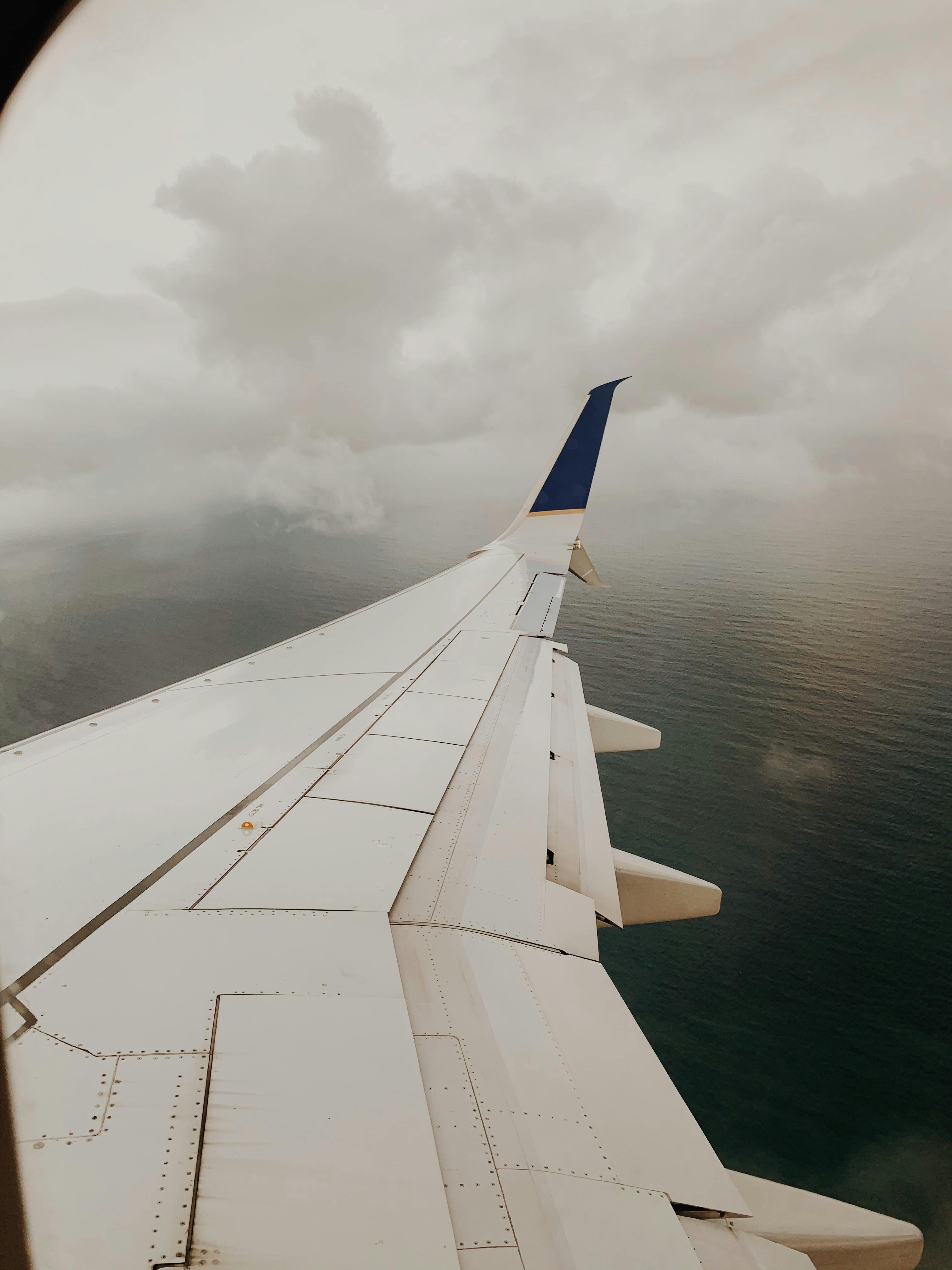 White Airplane Wing over the Clouds · Free Stock Photo
