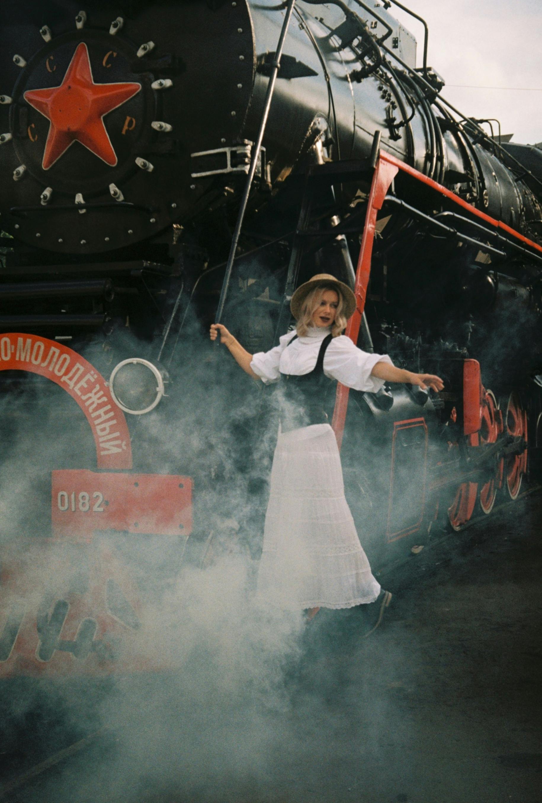 A Stylish Woman Posing on a Train · Free Stock Photo