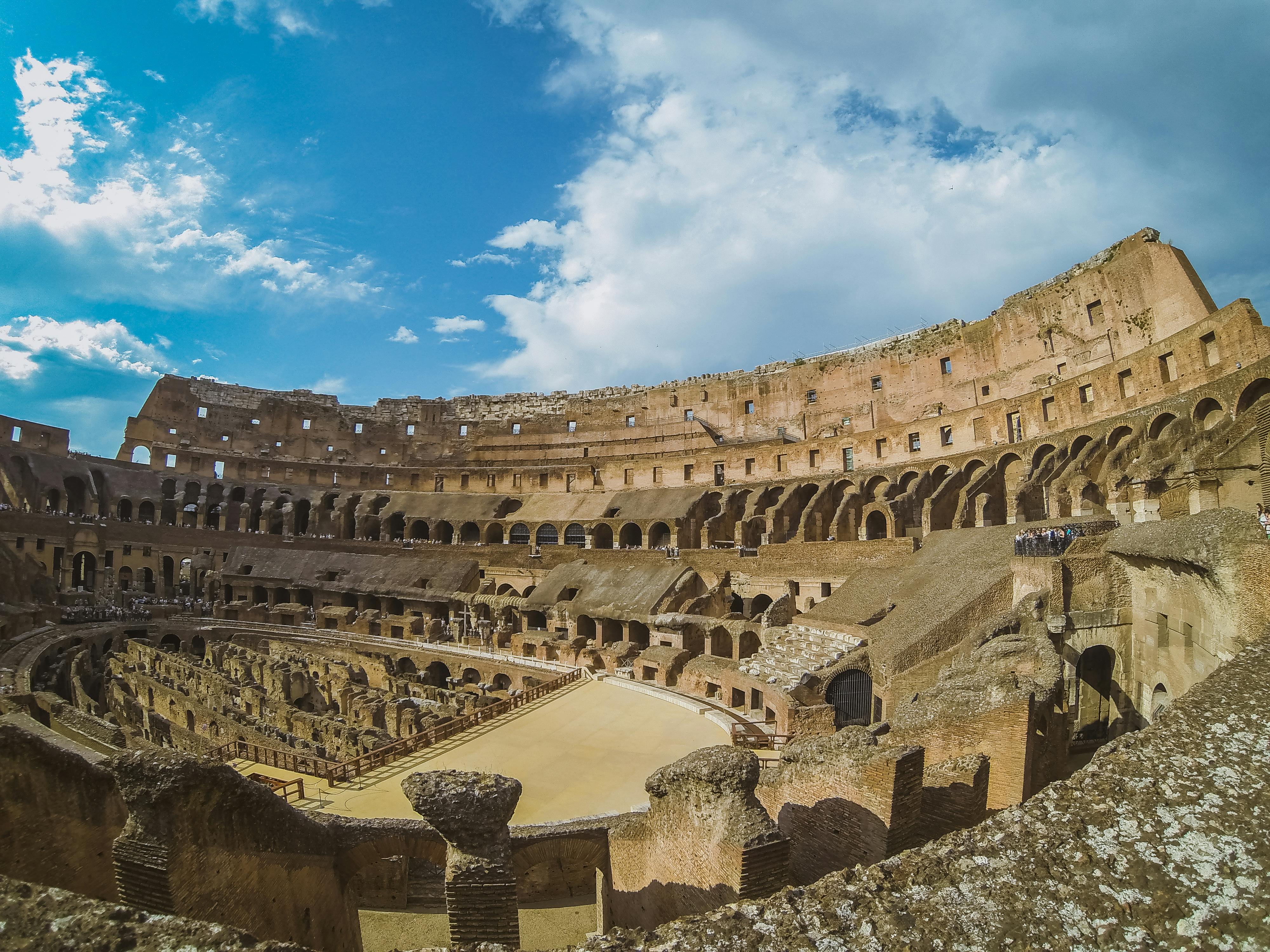 An Old Colosseum Under Blue Sky · Free Stock Photo