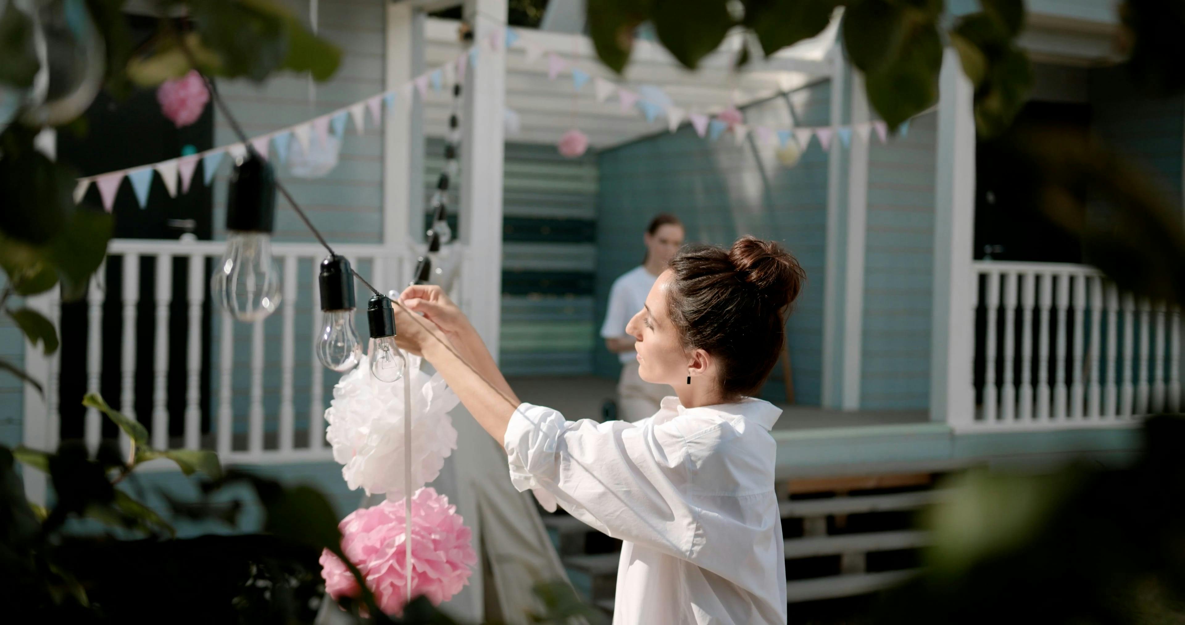 Women Setting Up Decorations Outside Their House Free Stock Video ...