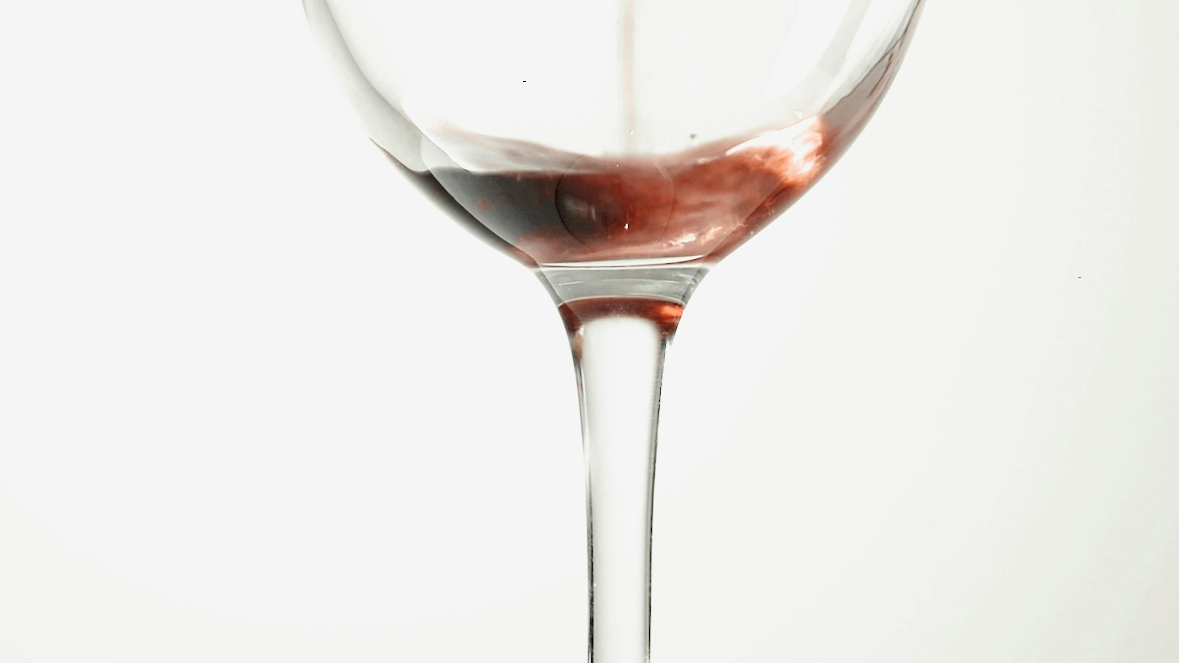 A Person Pouring Red Juice in Glass Full of Ice · Free Stock Video