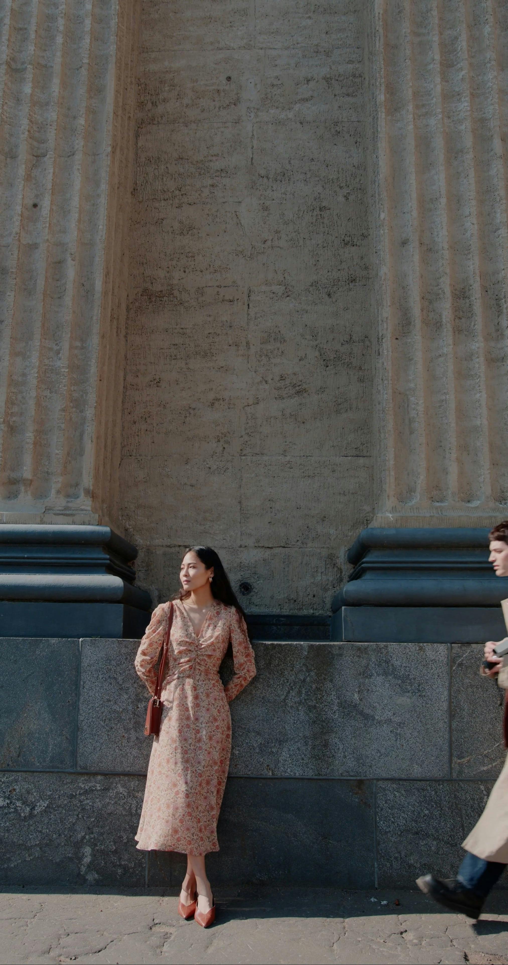 A Man Filming a Woman Leaning in between Columns Free Stock Video ...