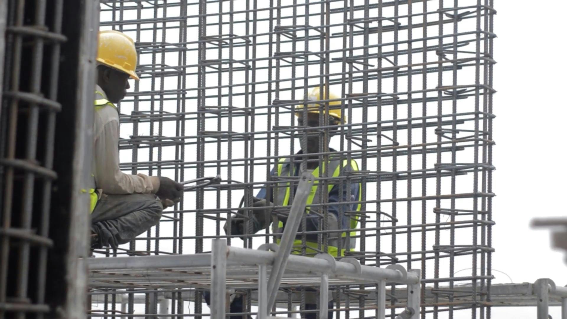 A Man Helping a Female Coworker at a Construction Site Free Stock Video ...