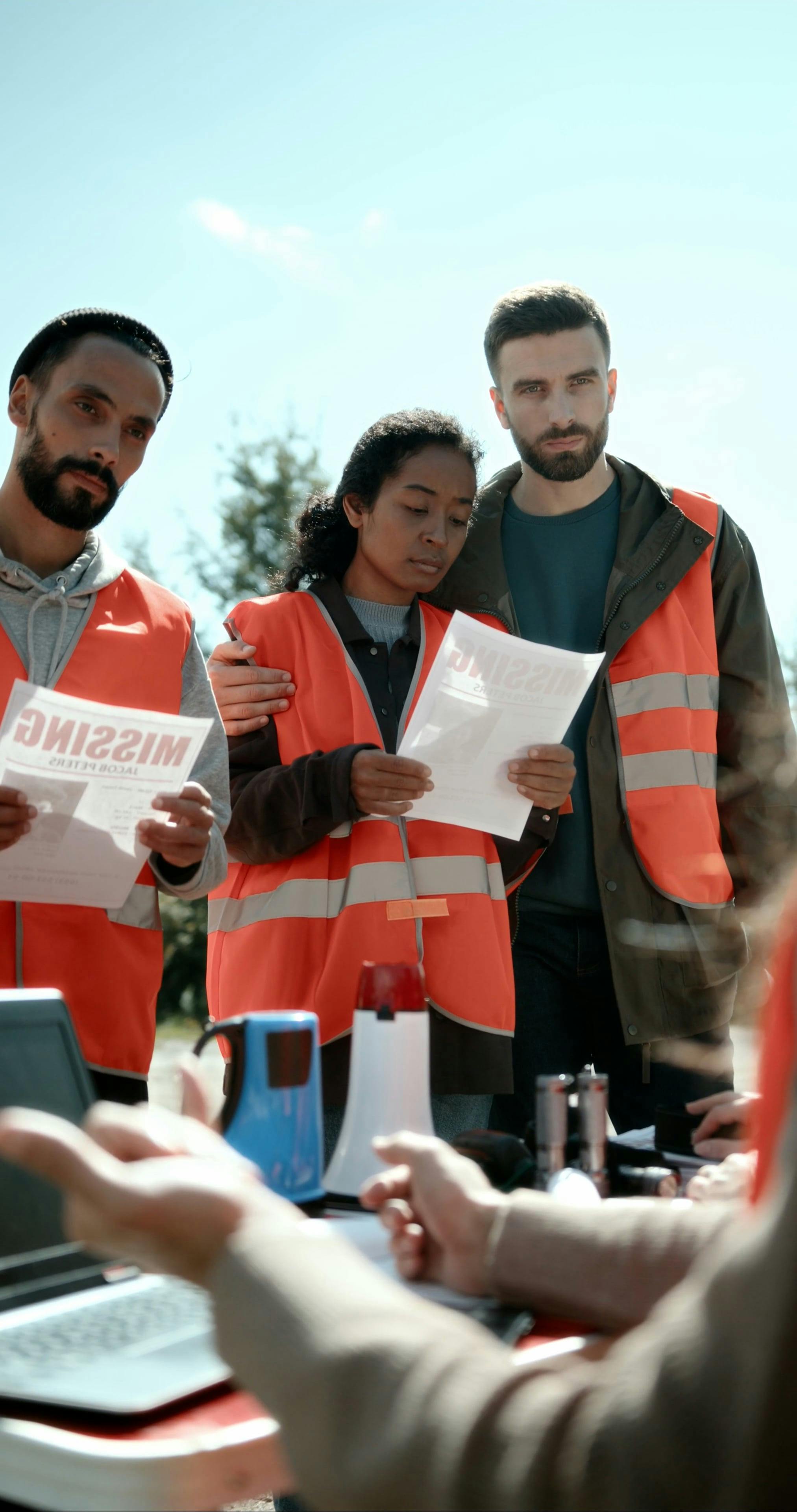 A Group of Volunteers Holding Missing Person Posters Free Stock Video ...