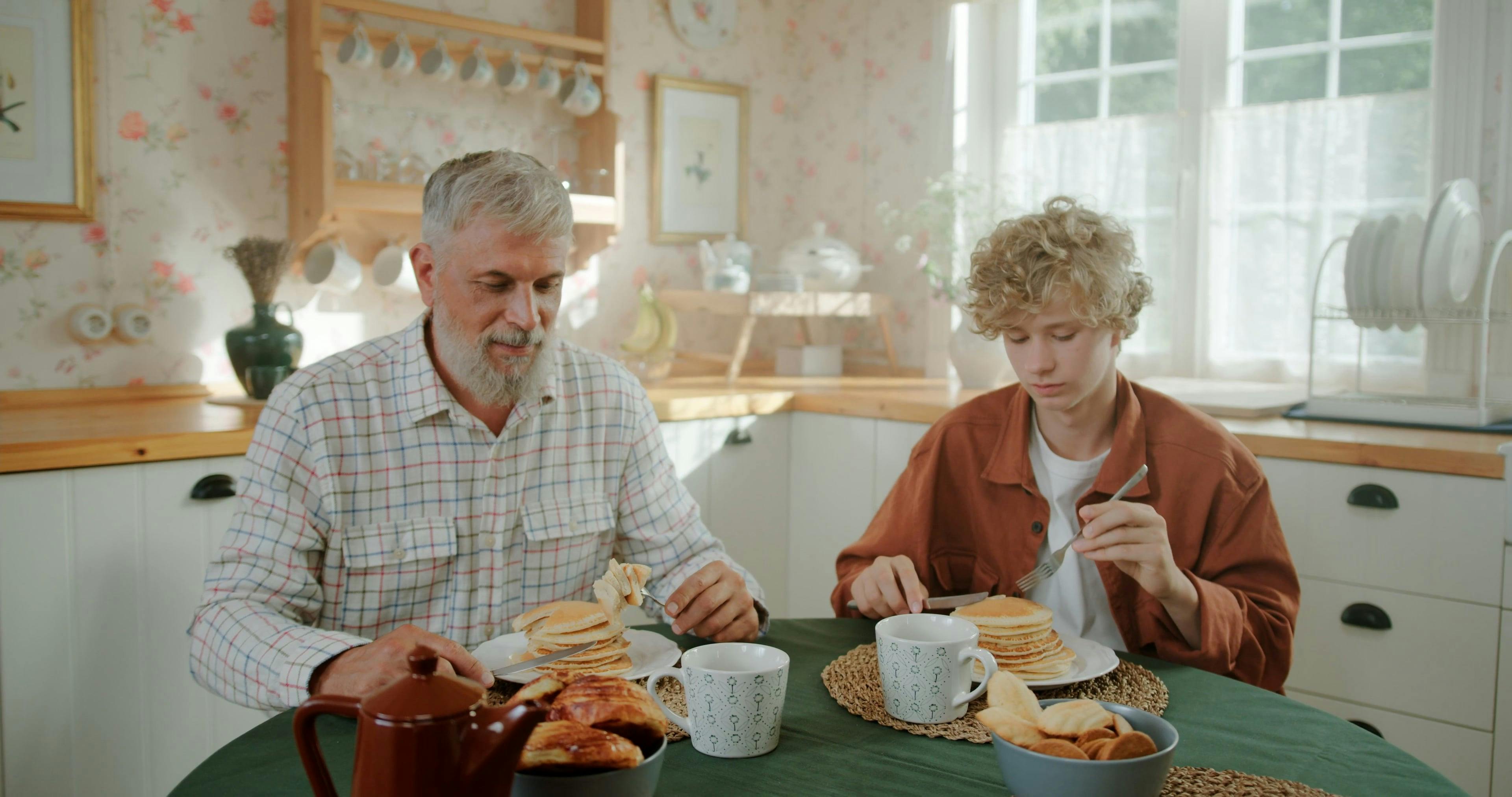 Elderly Man and a Boy Eating Pancakes Together Free Stock Video Footage ...