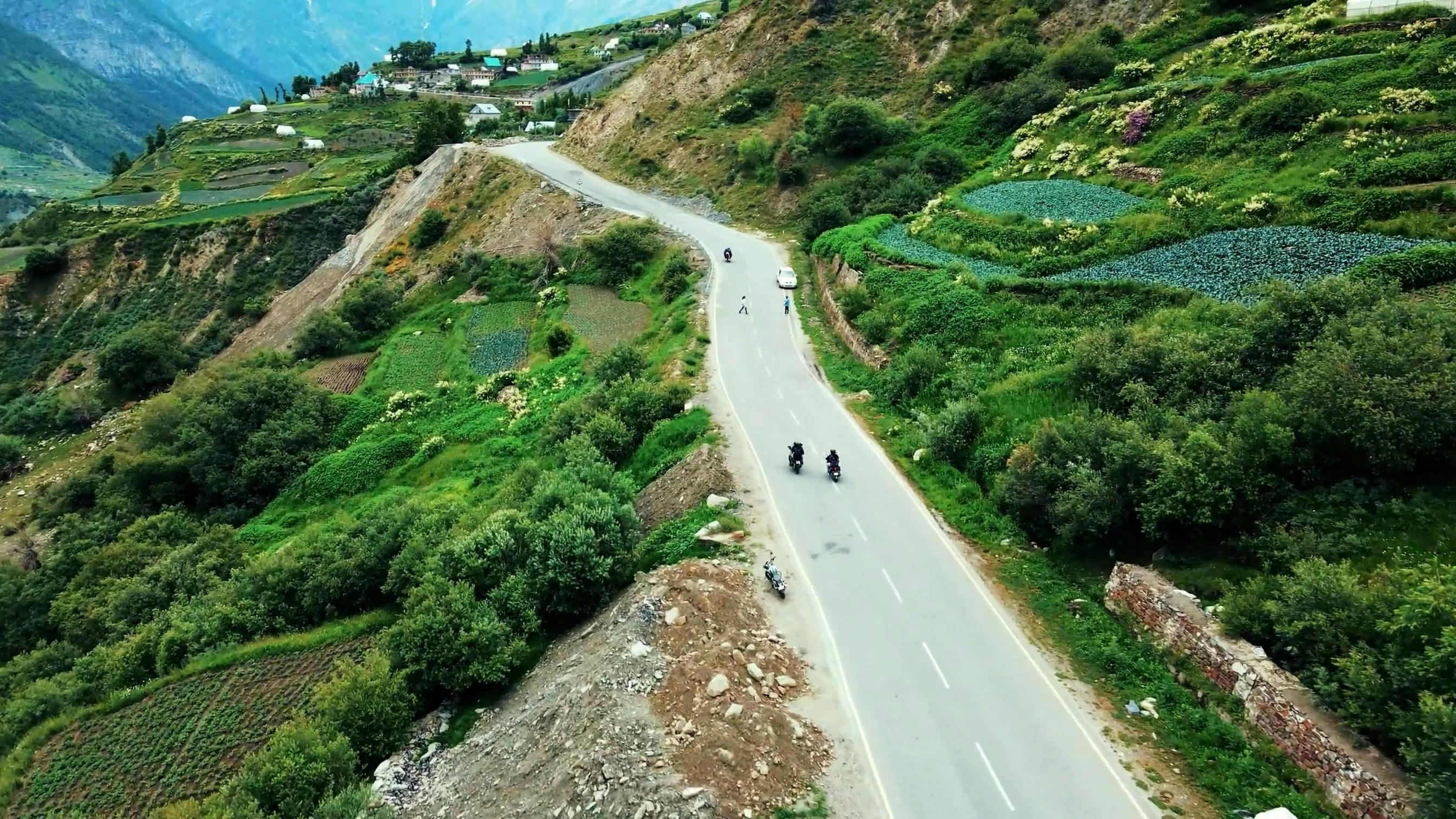 Aerial View of Bikers Traveling on Motorcycles along Road in Mountains ...