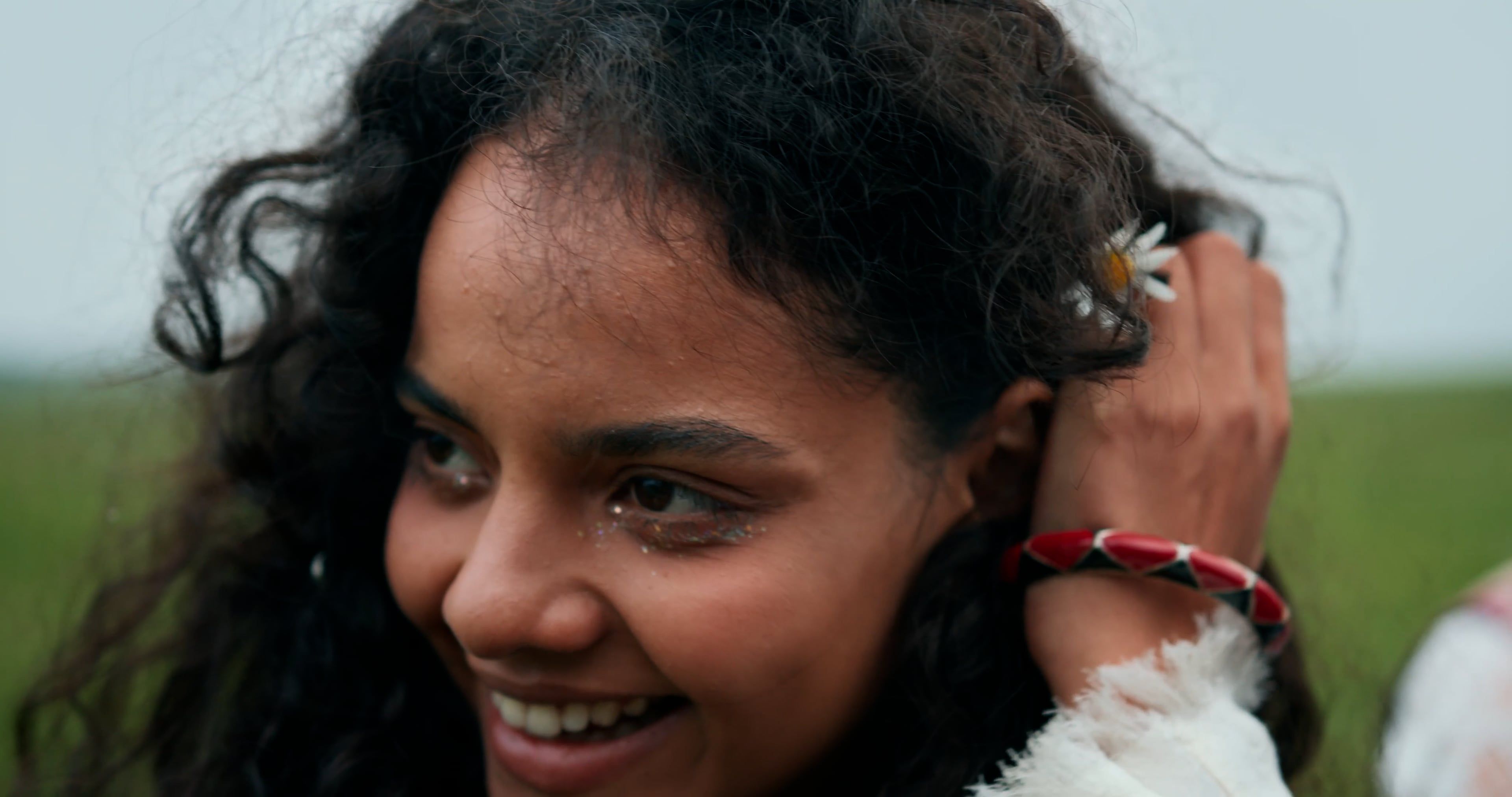 A Woman Putting a Flower on Her Ears while Showing it to Her Friend ...