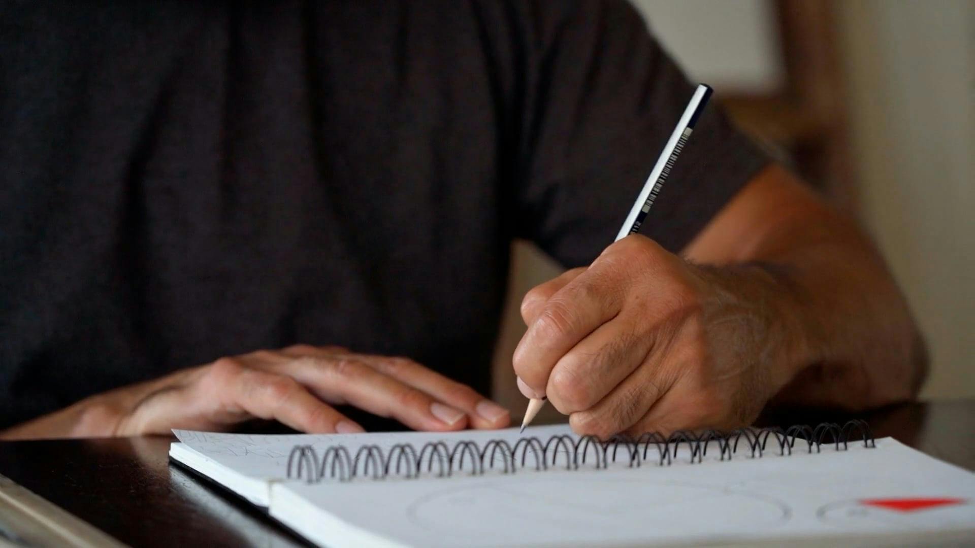 Writing And Erasing On A Sheet Of Paper · Free Stock Video