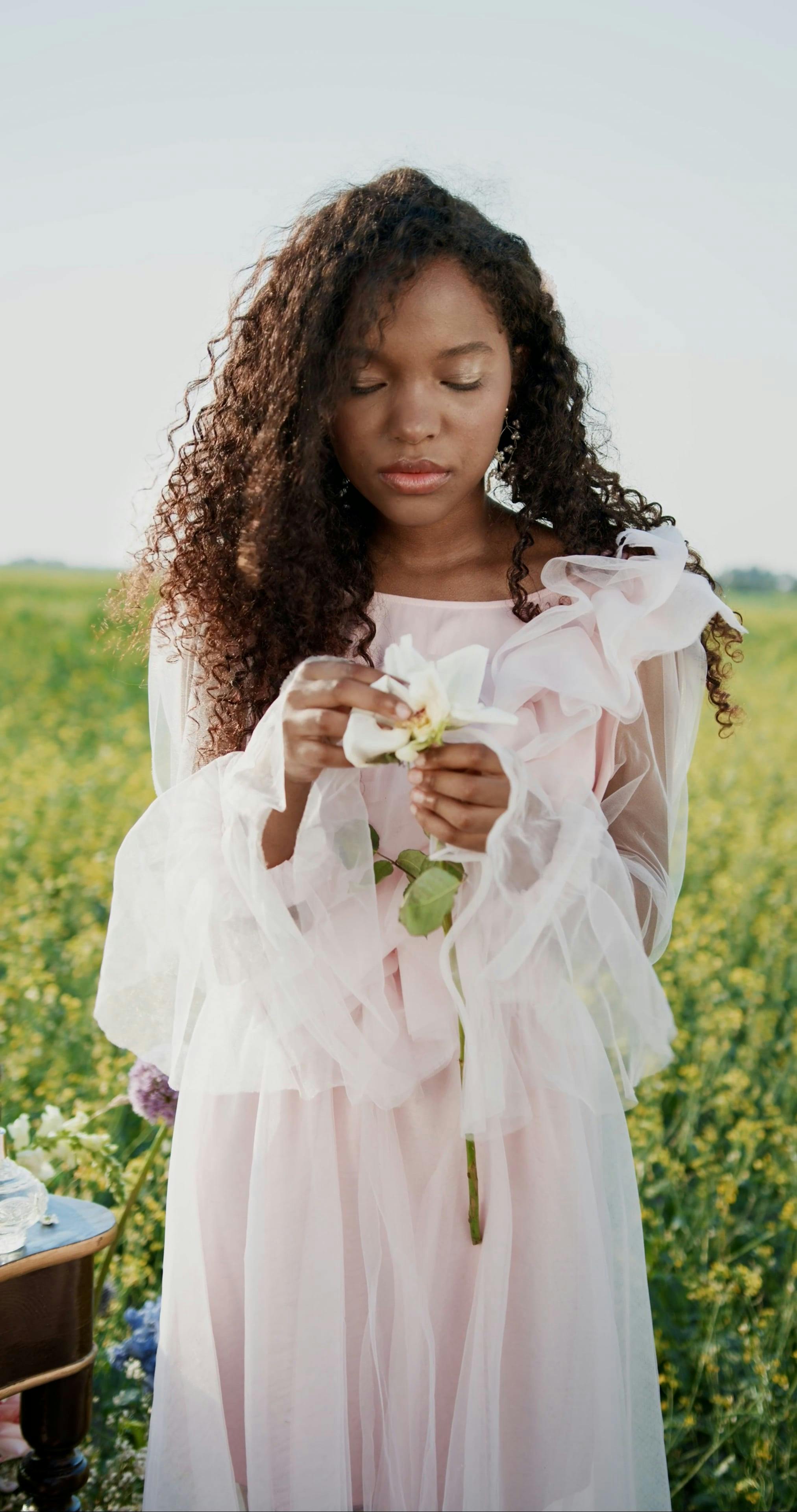 A Young Woman Pulling the Petals of a Flower Free Stock Video Footage ...