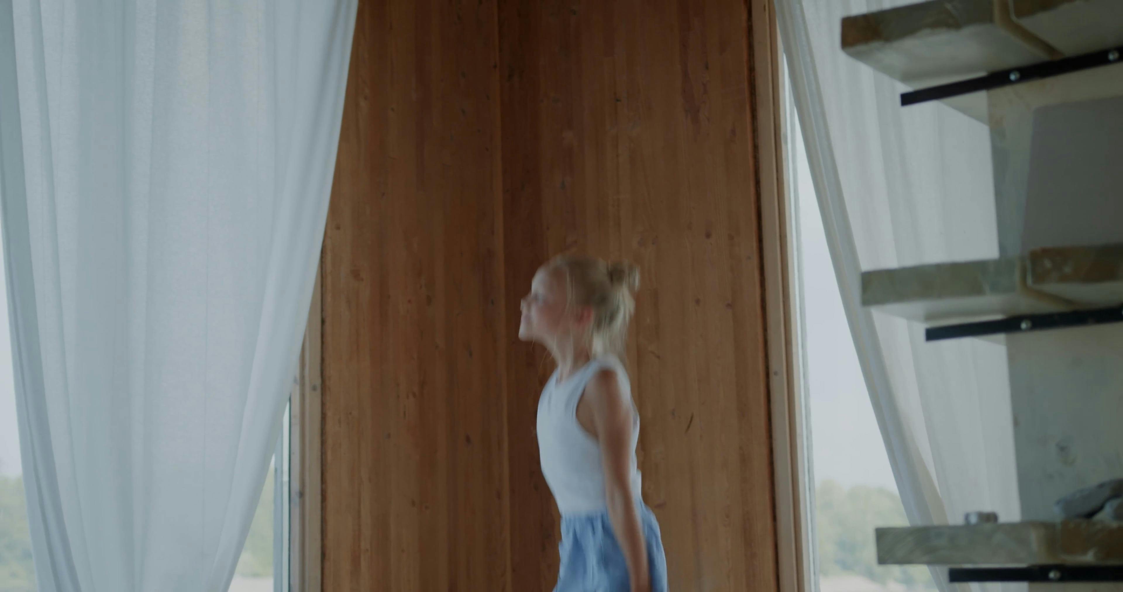 A Young Girl Getting Up from Bed while Looking at the Sea View Free ...