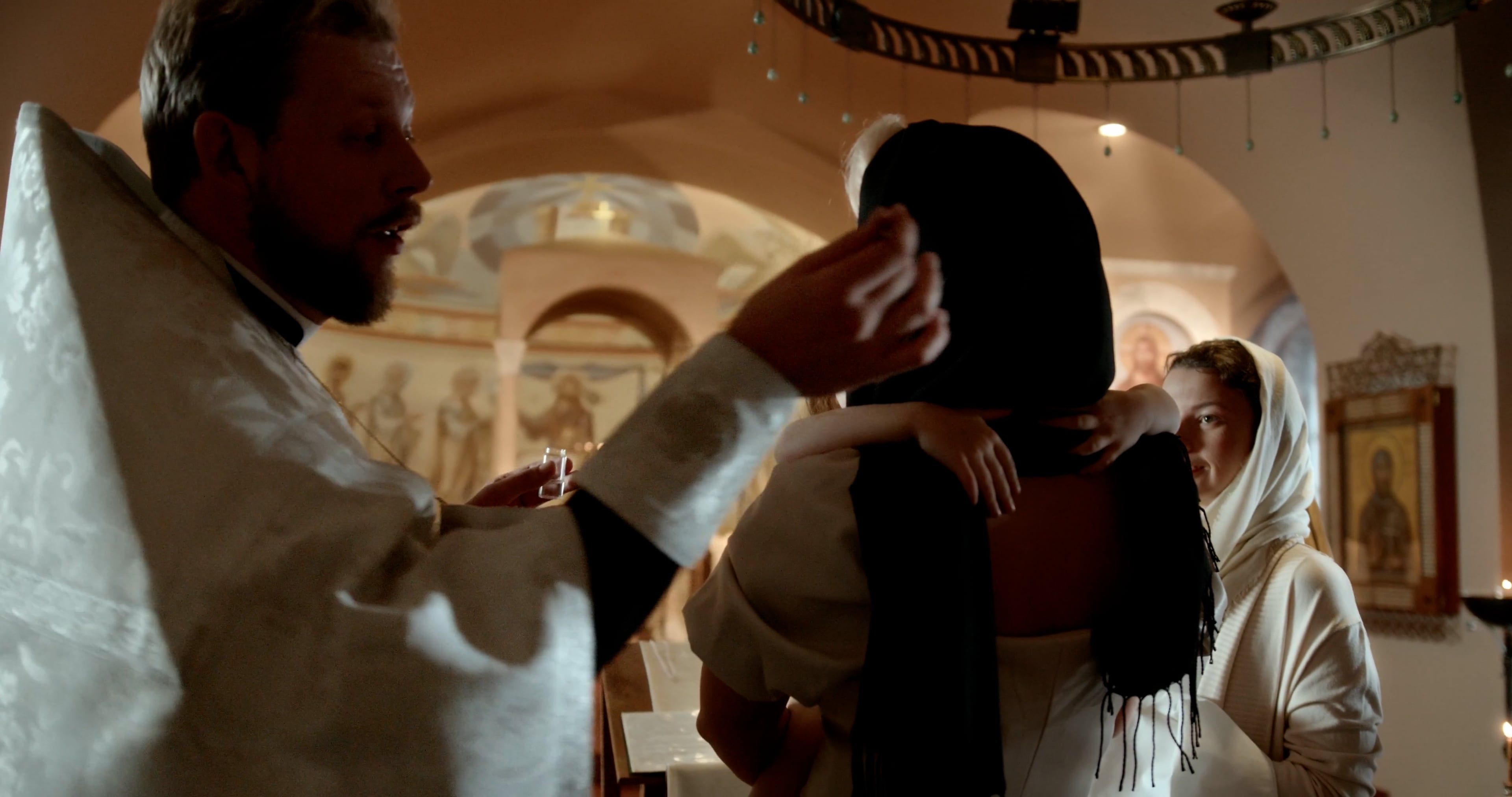 A Priest Applying Oil on a Child during Religious Ceremony Free Stock ...