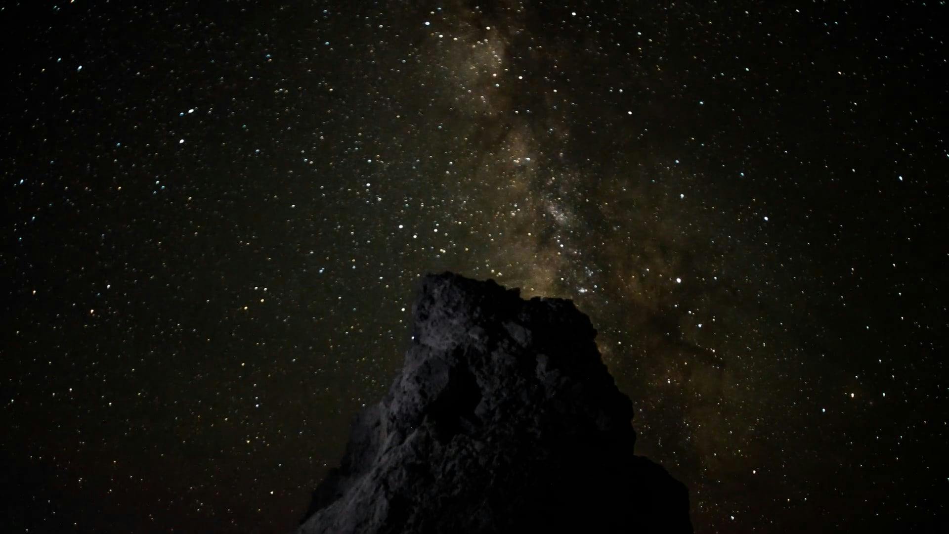 Rock Against Milky Way in Night Sky · Free Stock Video