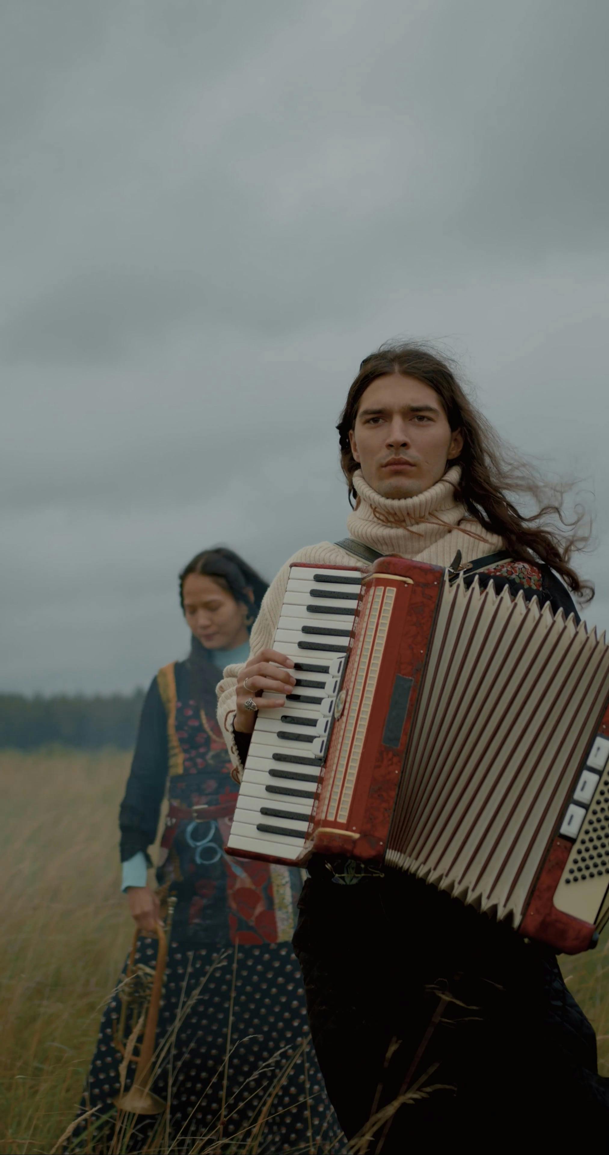 A Gypsy Couple with Musical Instruments Standing in a Field Free Stock ...