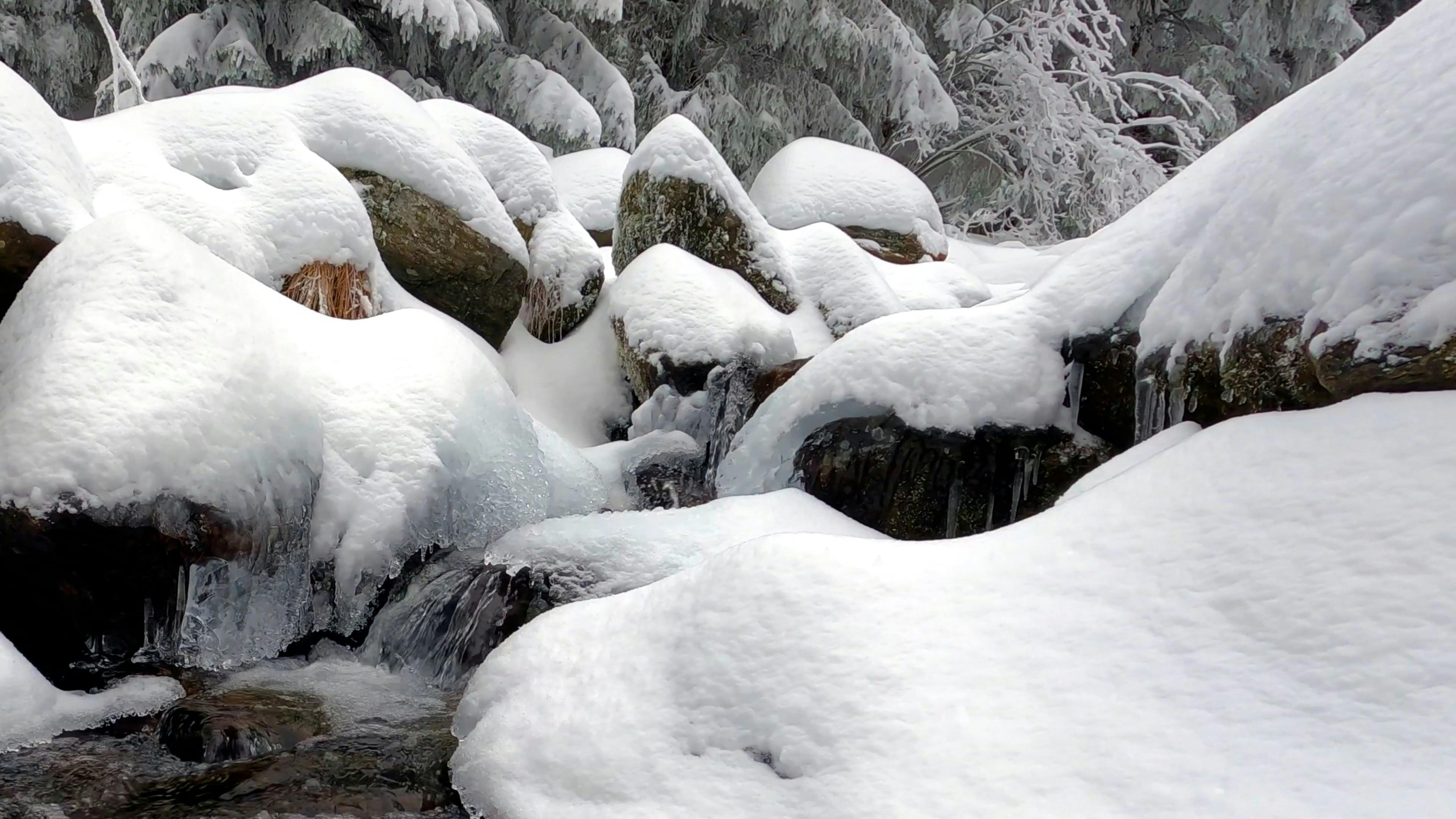 Crystal Clear Stream Flowing among Snow Covered Rocks Free Stock Video ...