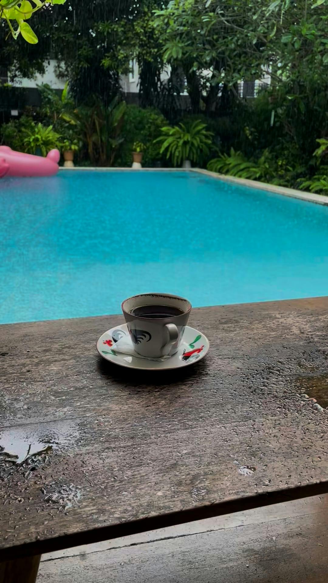 Coffee on Table near Pool During Rain · Free Stock Video
