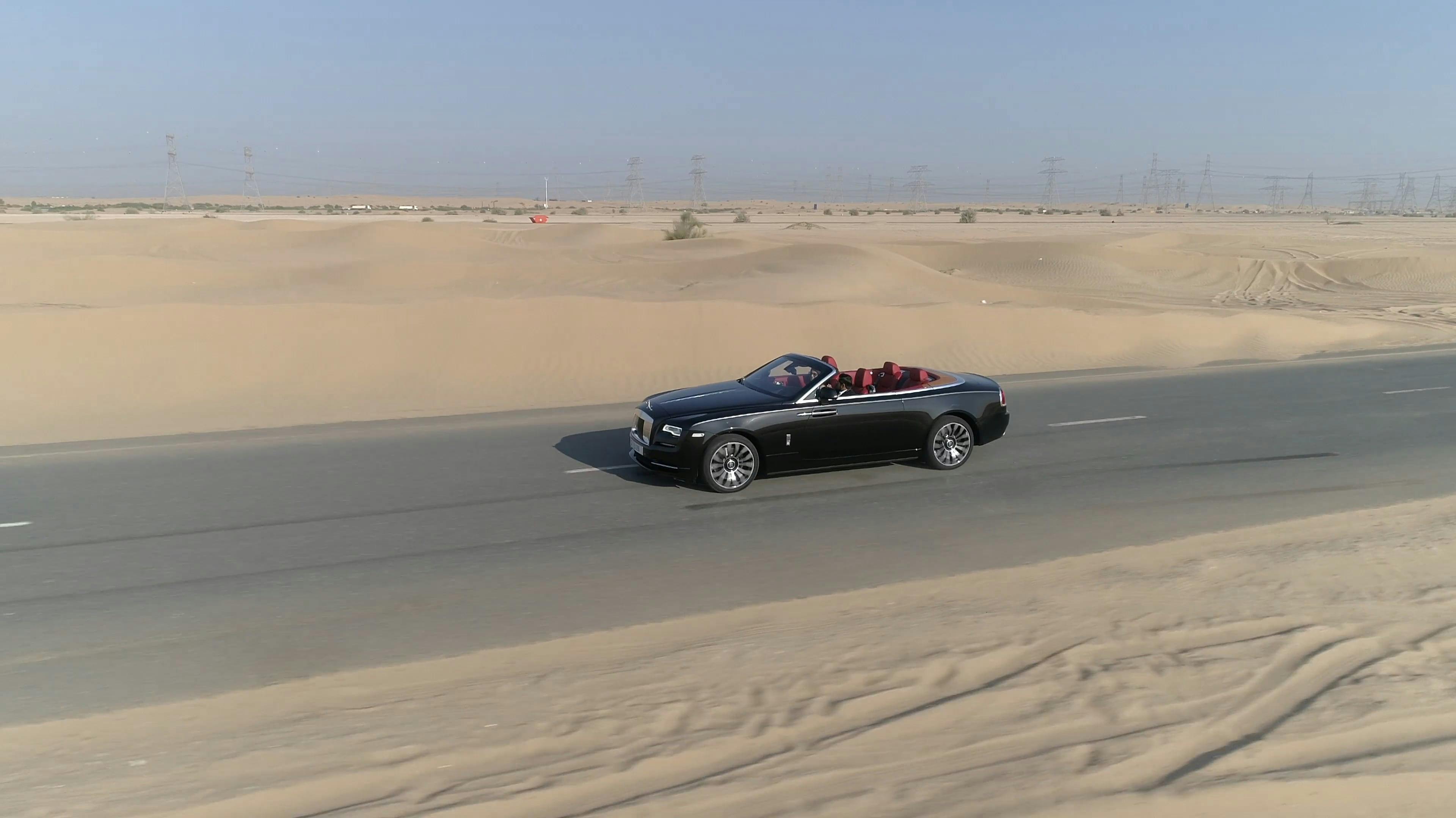 A Convertible Car Passing Through The Curves Of A Road Built On The ...