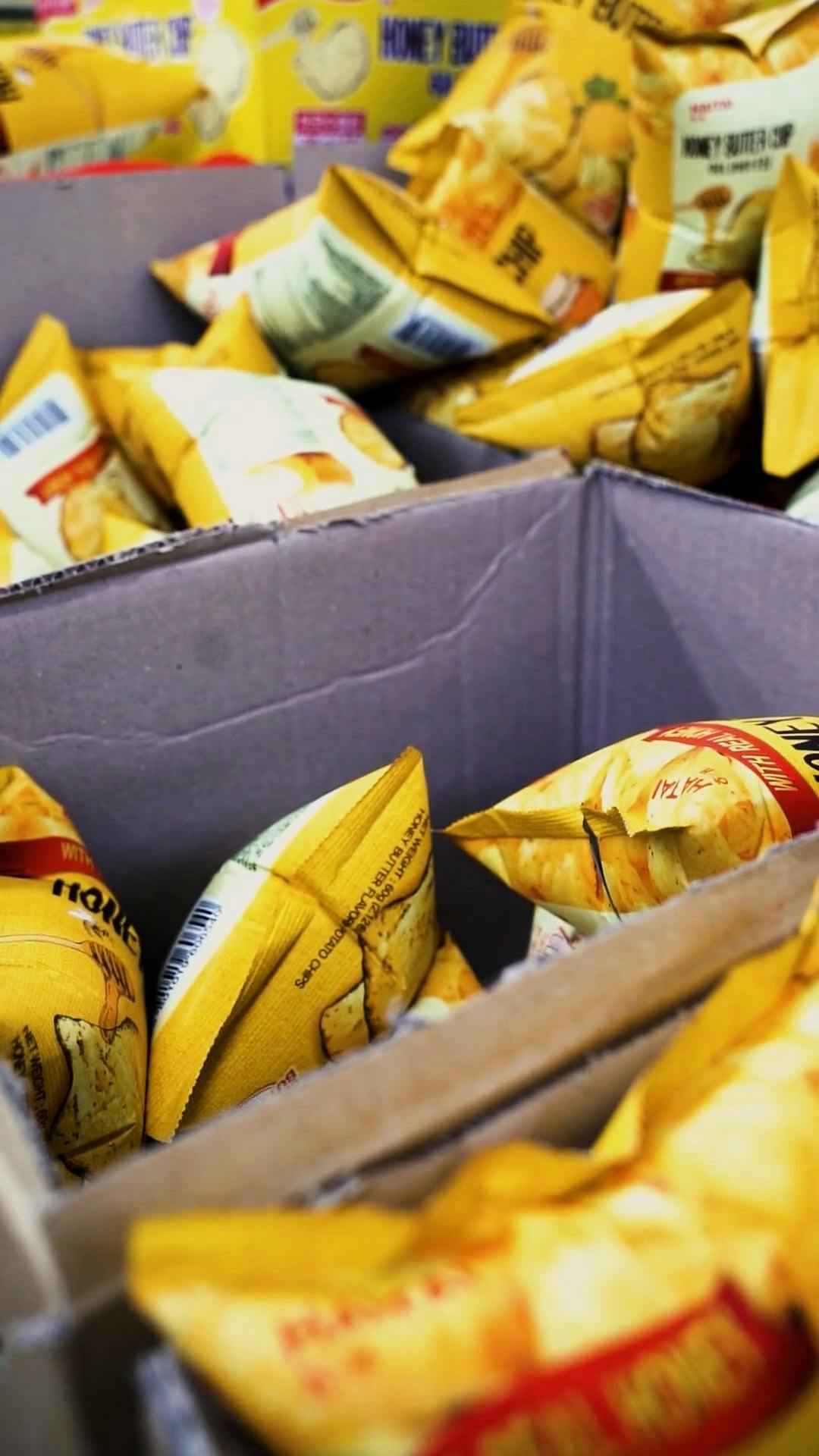 Happy Caucasian Woman Comparing Two Glass Jars in a Grocery Store Free ...