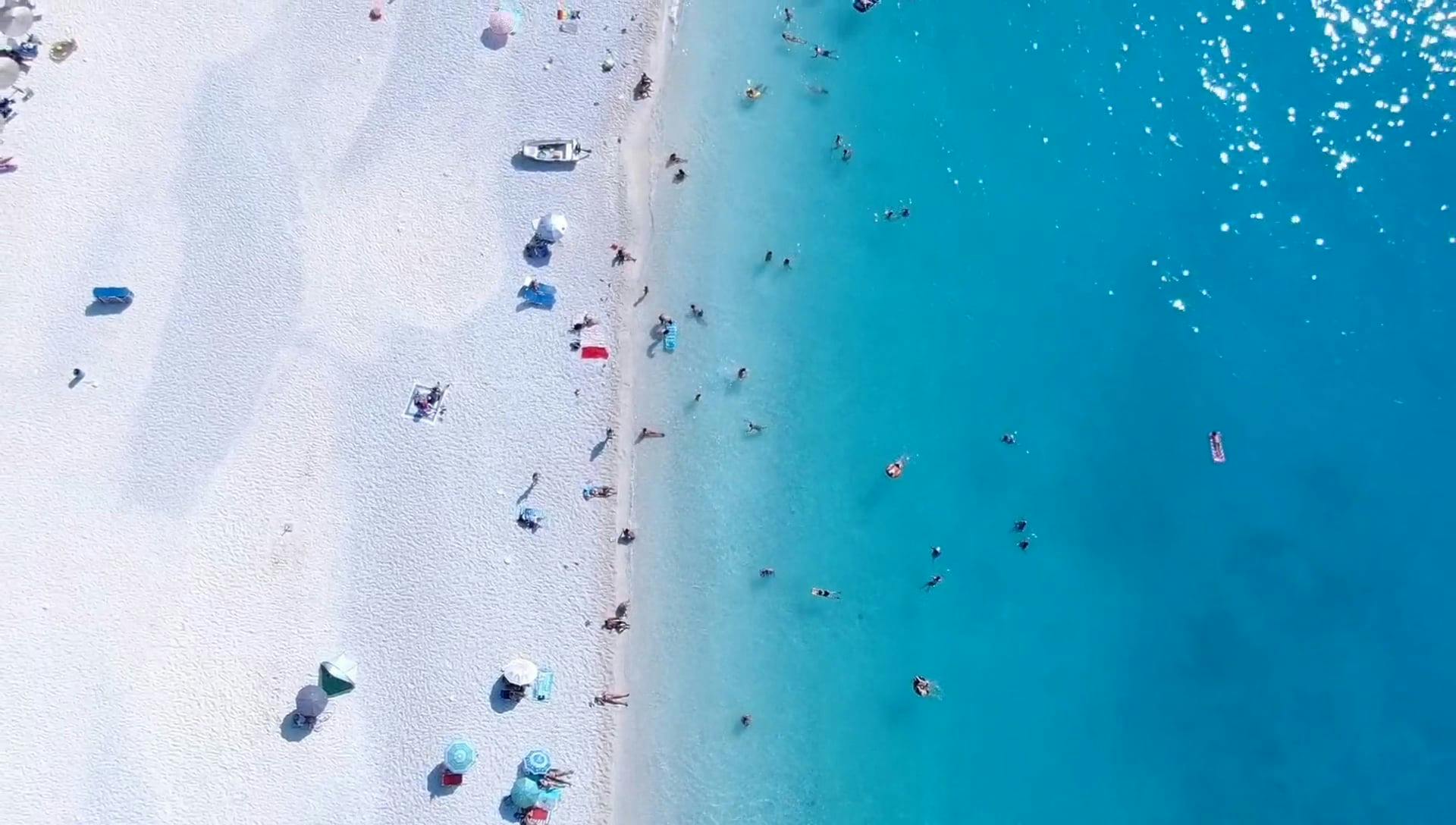 Couple Walking on a Beach Filmed with a Drone Free Stock Video Footage ...