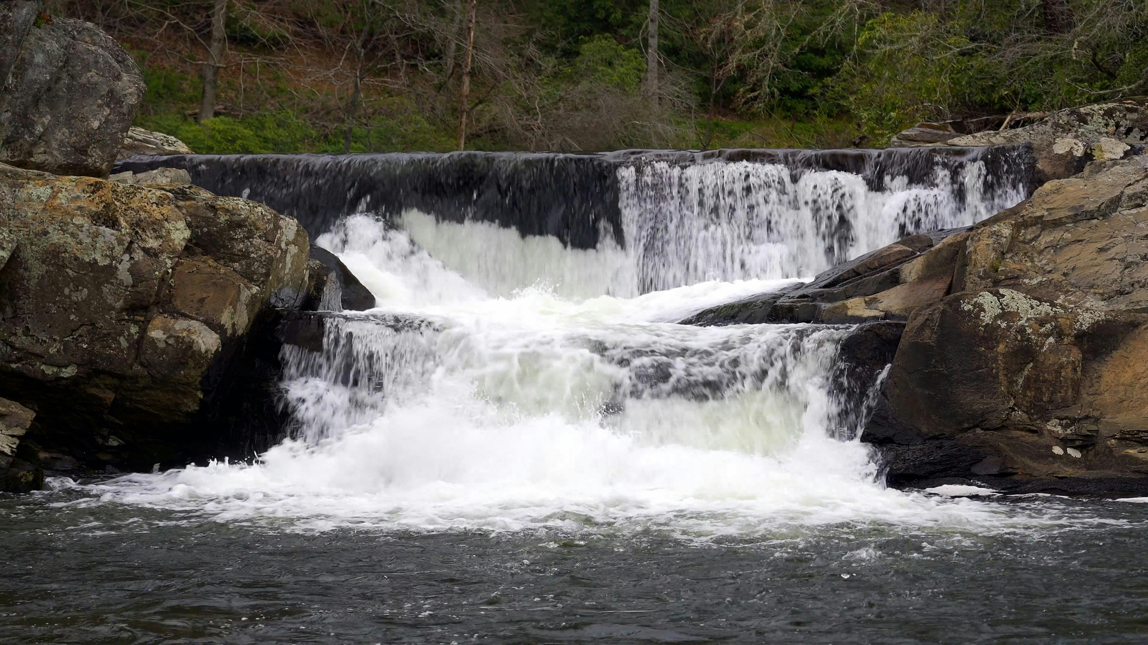 A Waterfalls Cascading Through Multi-layer Of Rocks Formation Free ...