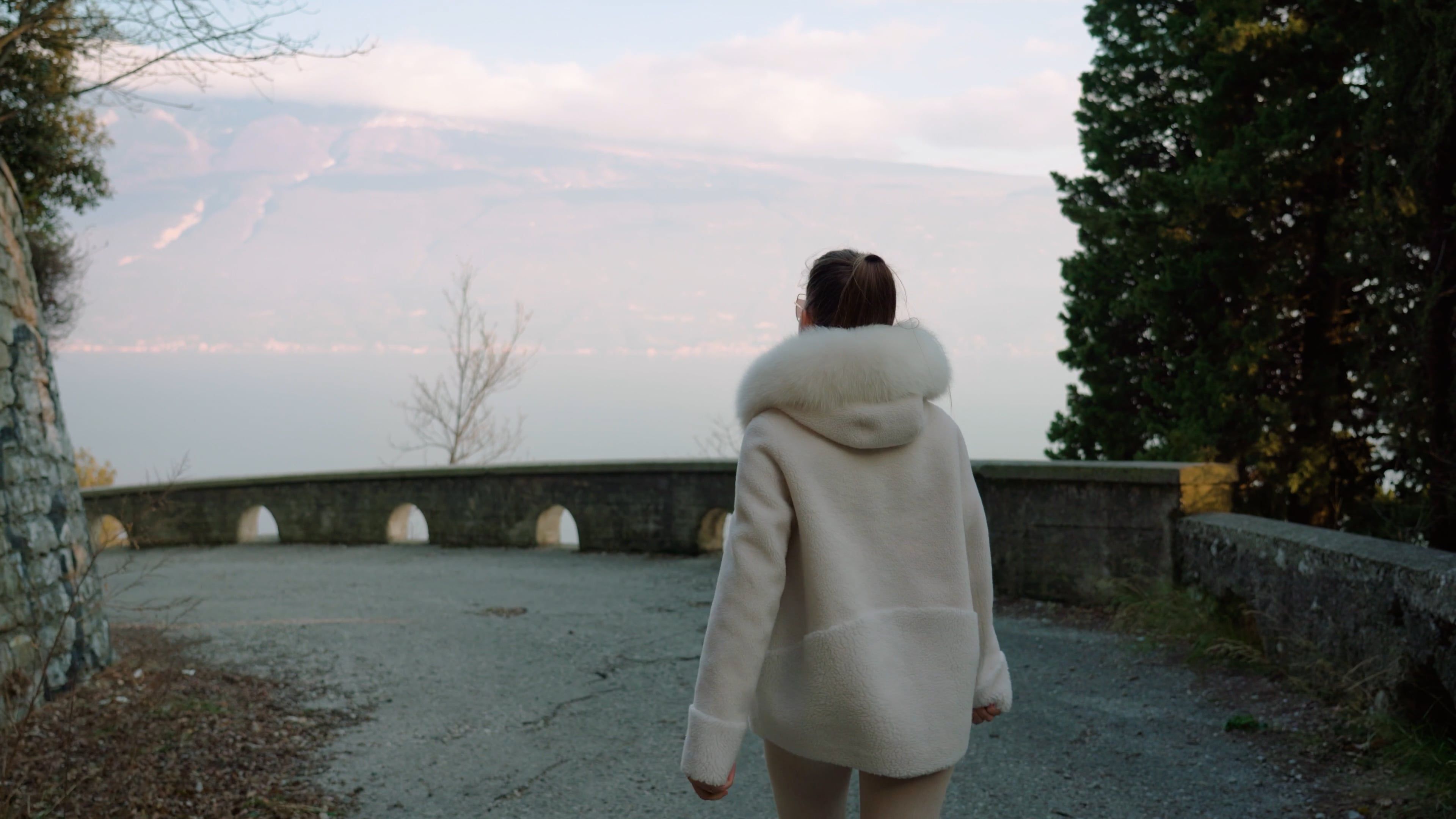 Back View of a Woman Walking on a Road with Panoramic View Free Stock ...