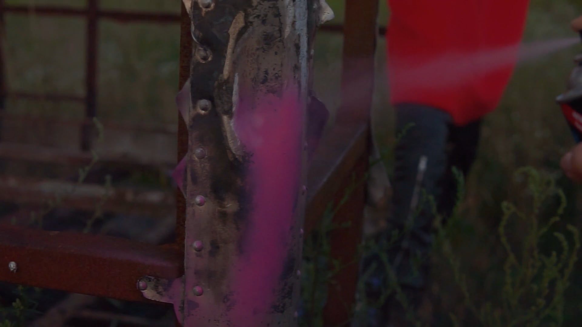 Close up of a Person Using Spray Paint on a Rusty Metal Structure Free ...