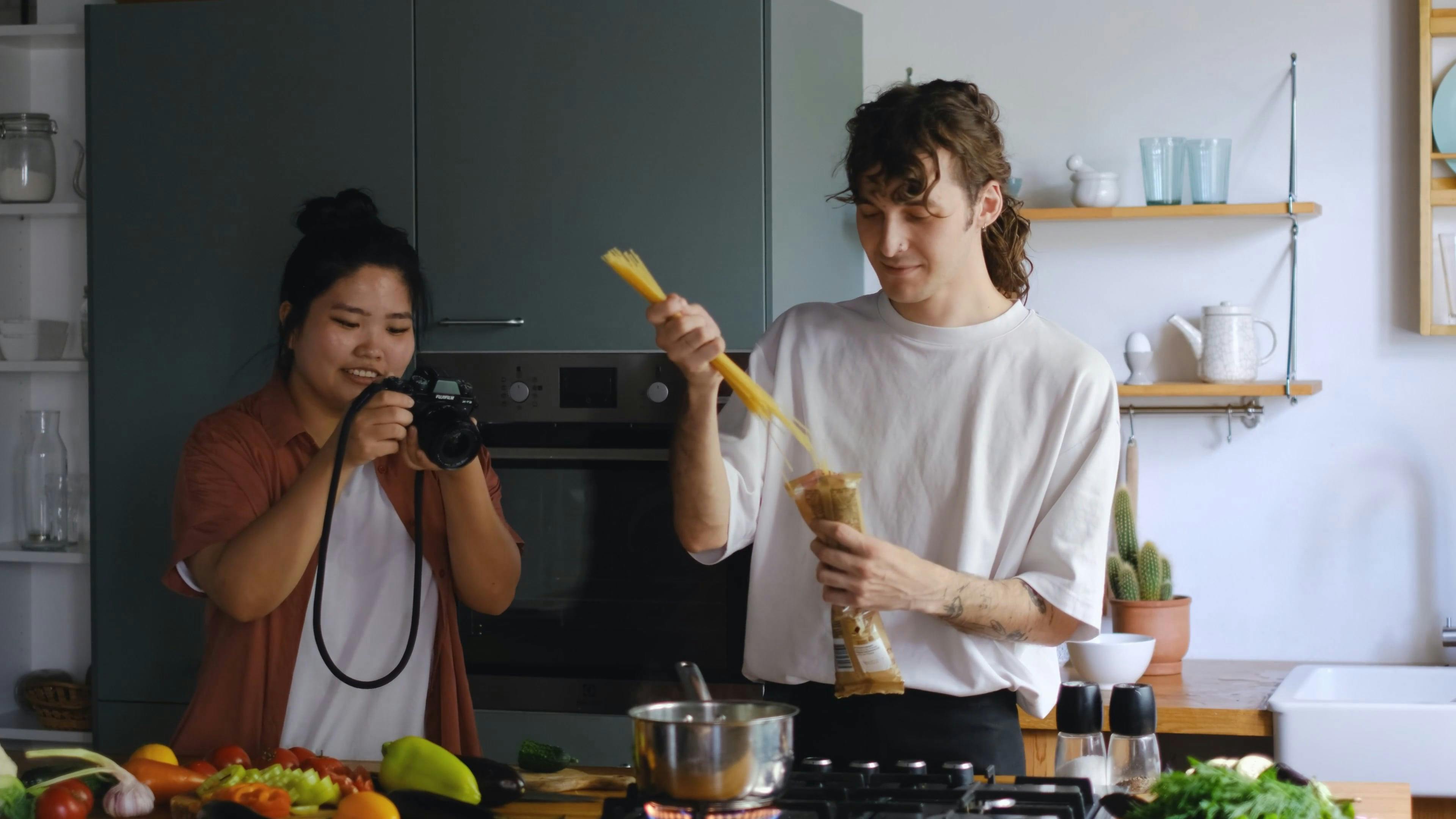 Food Vloggers Recording a Video while Cooking Pasta Free Stock Video ...