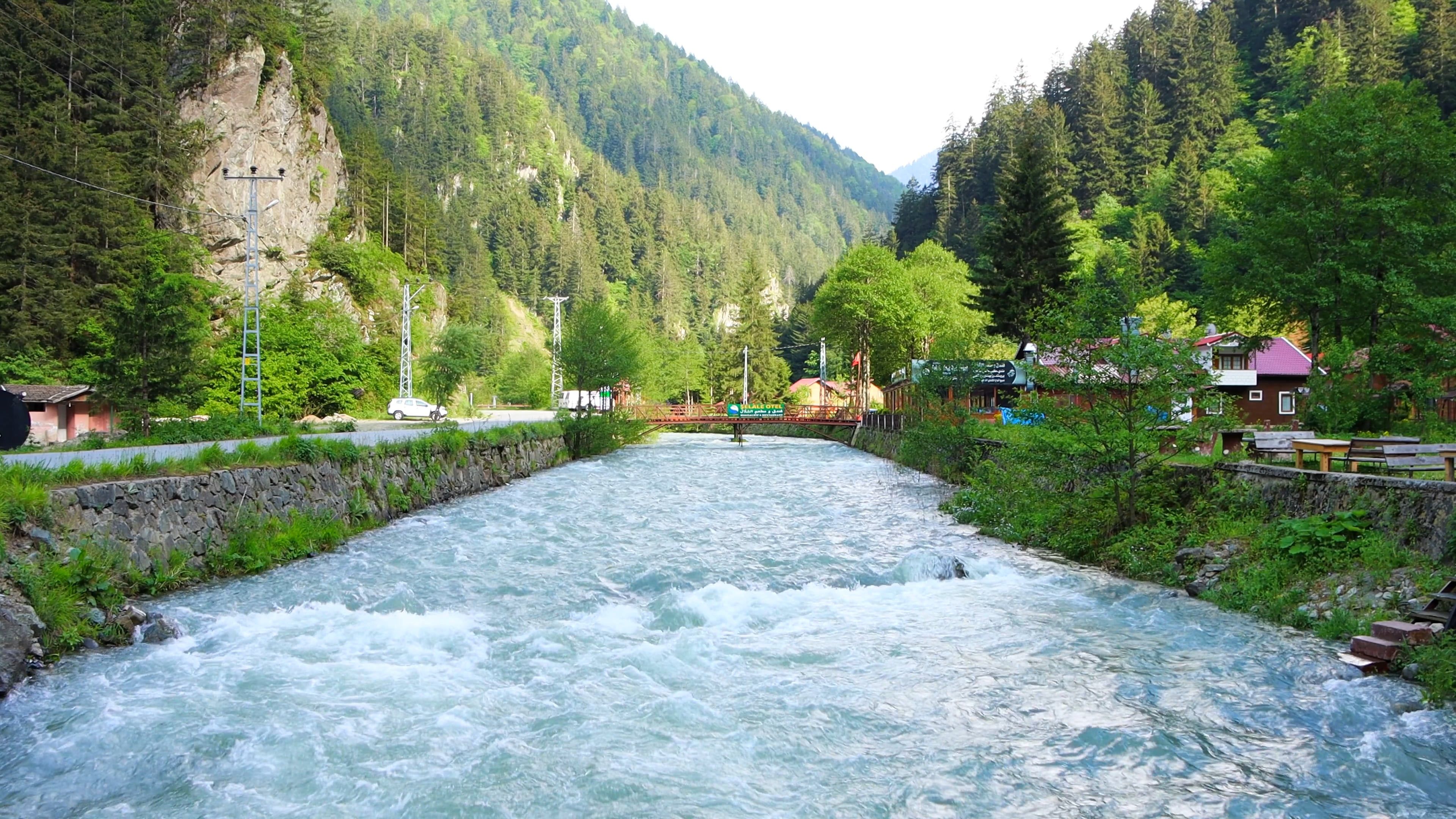 A Village and a Flowing River in a Mountain Landscape Free Stock Video ...