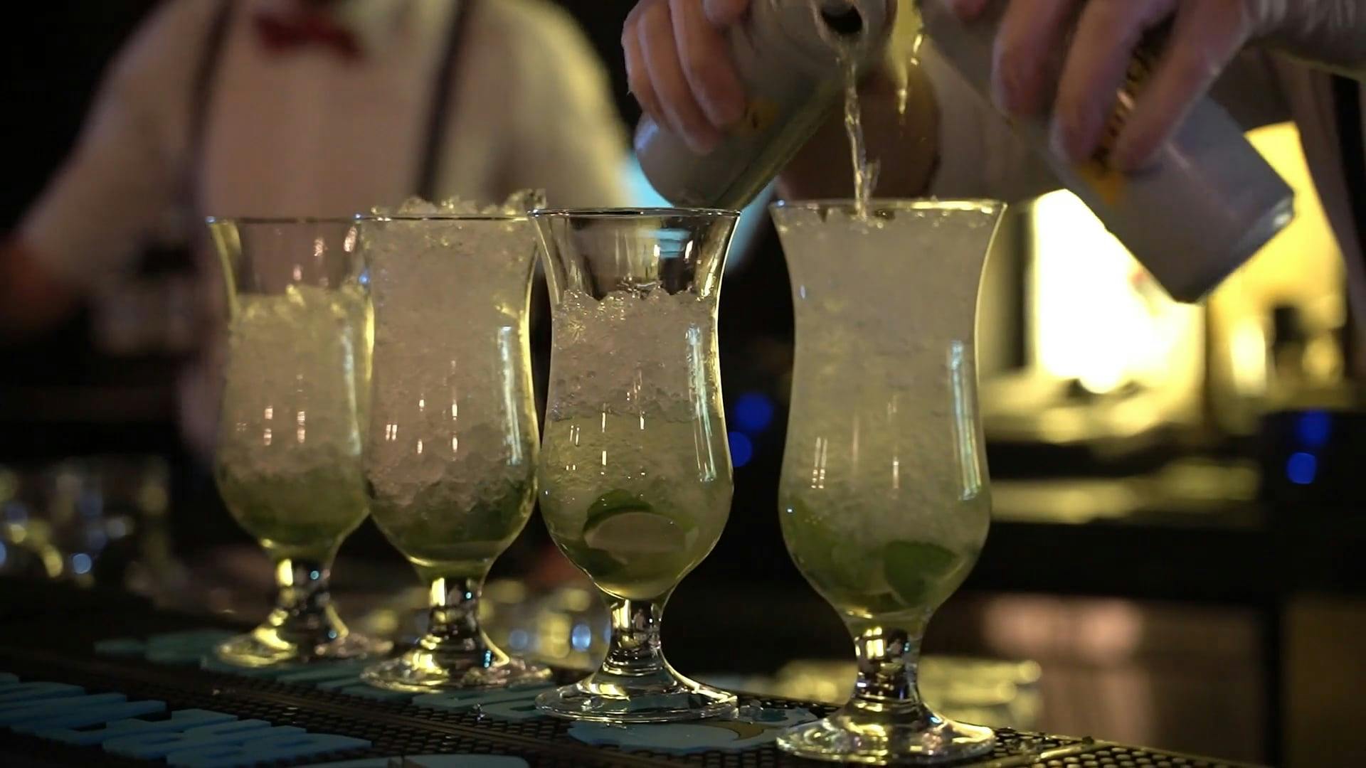 Close-up View of Bartender Pouring Drink into Wineglasses Free Stock ...