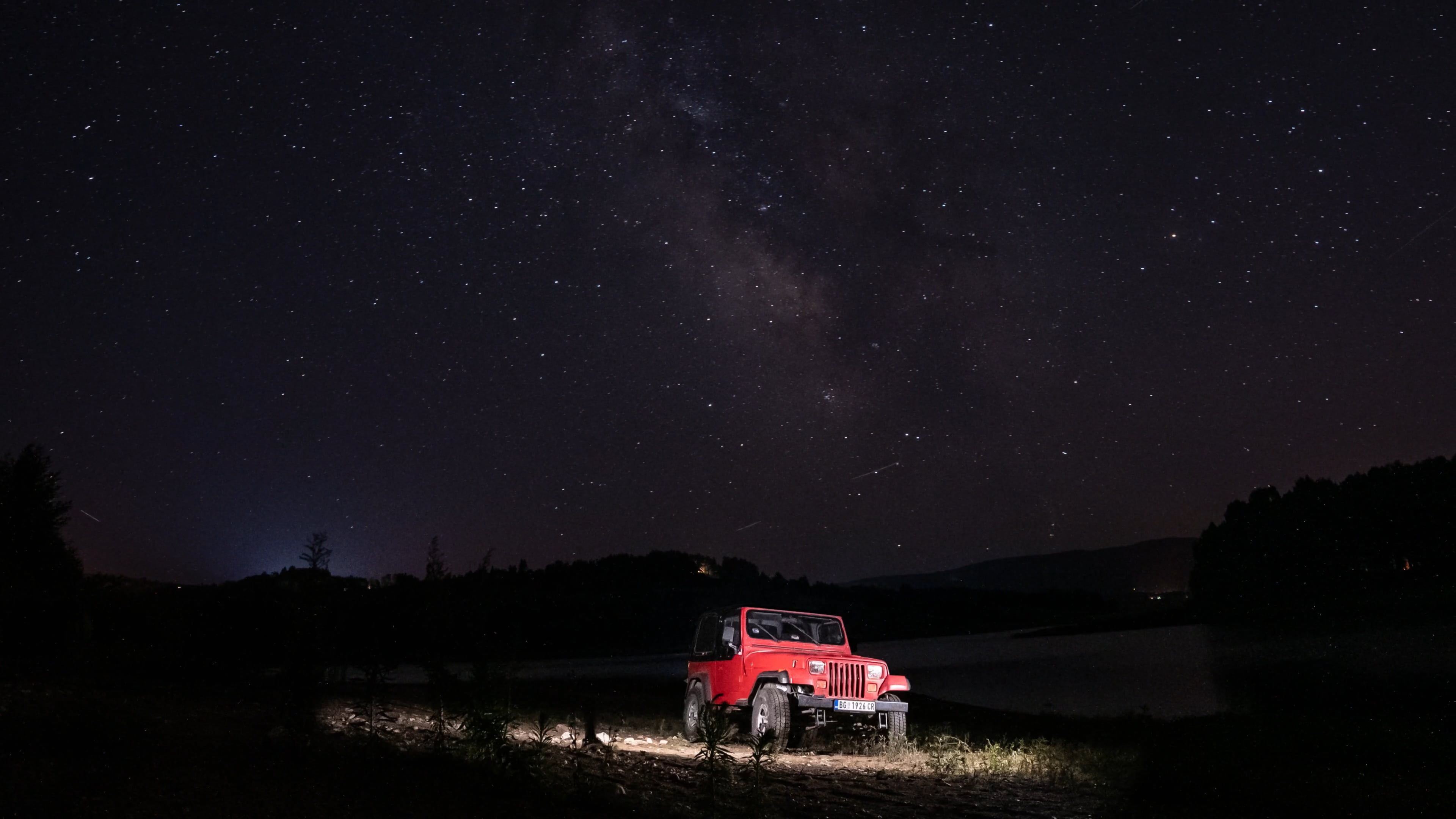 A Jeep Parked by a Lake under a Starry Night Sky Free Stock Video ...