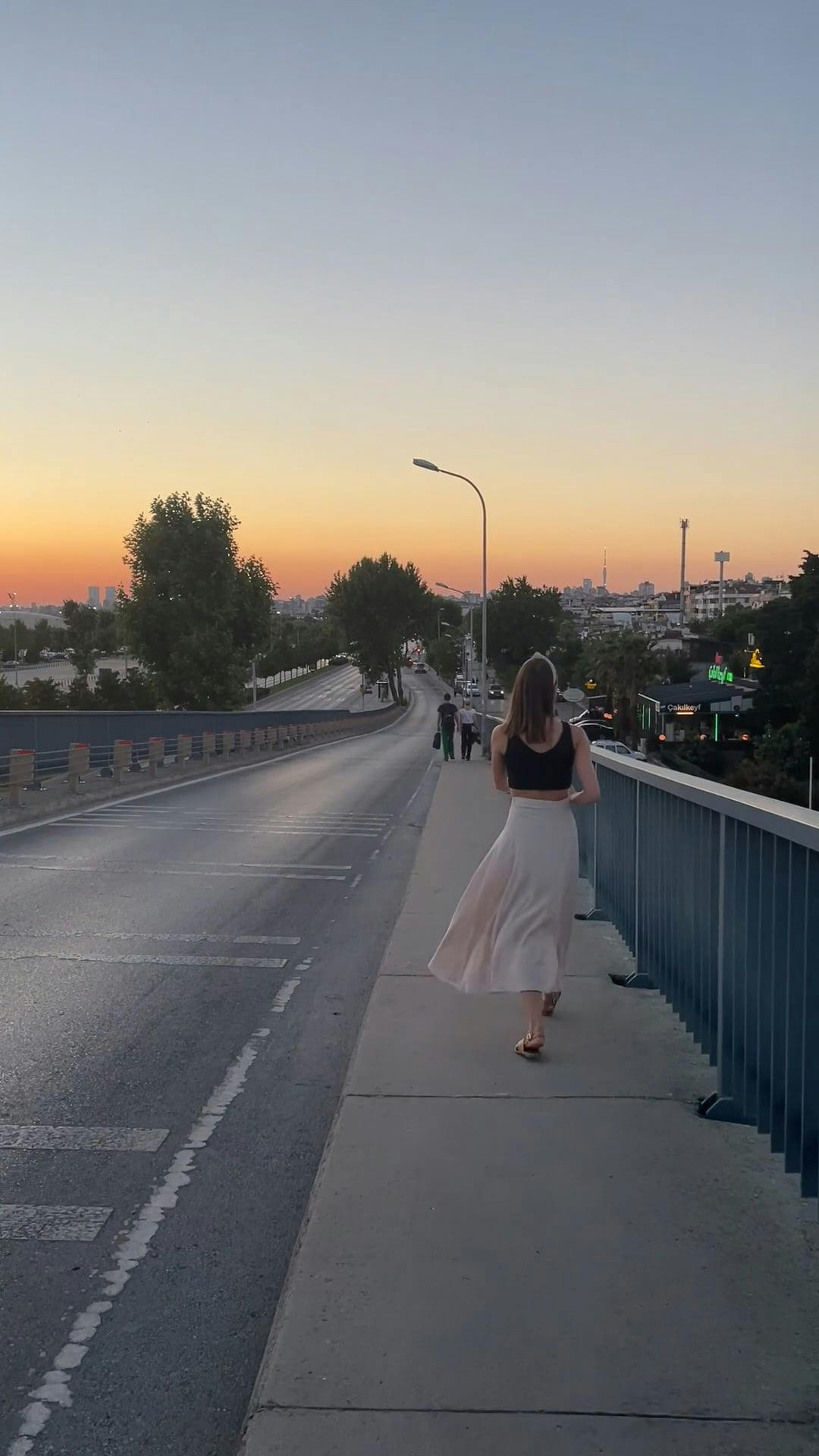 Back View of a Woman Walking on a Bridge at Sunset Free Stock Video ...