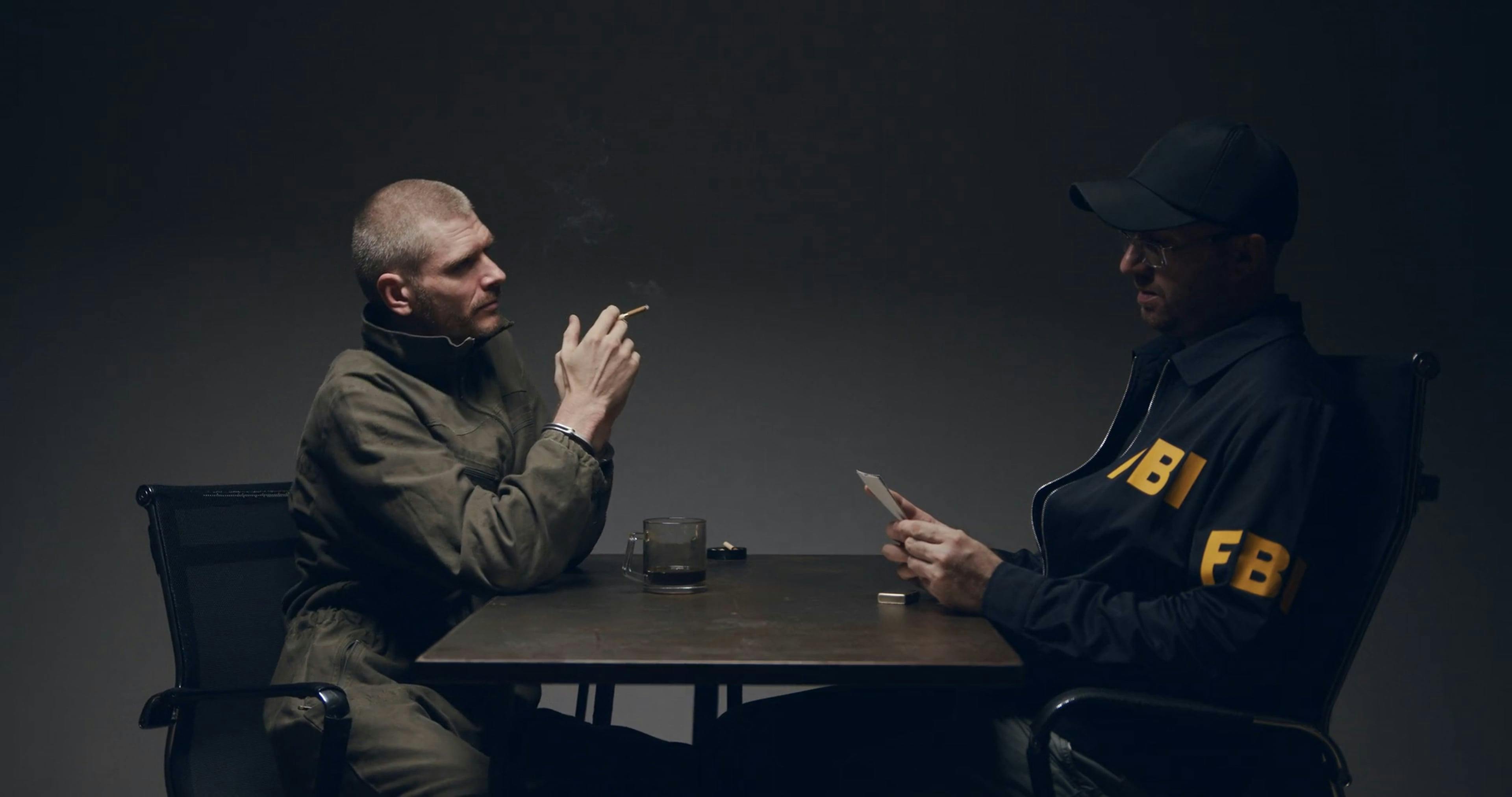 An FBI Agent Showing Photos to a Handcuffed Criminal Free Stock Video ...