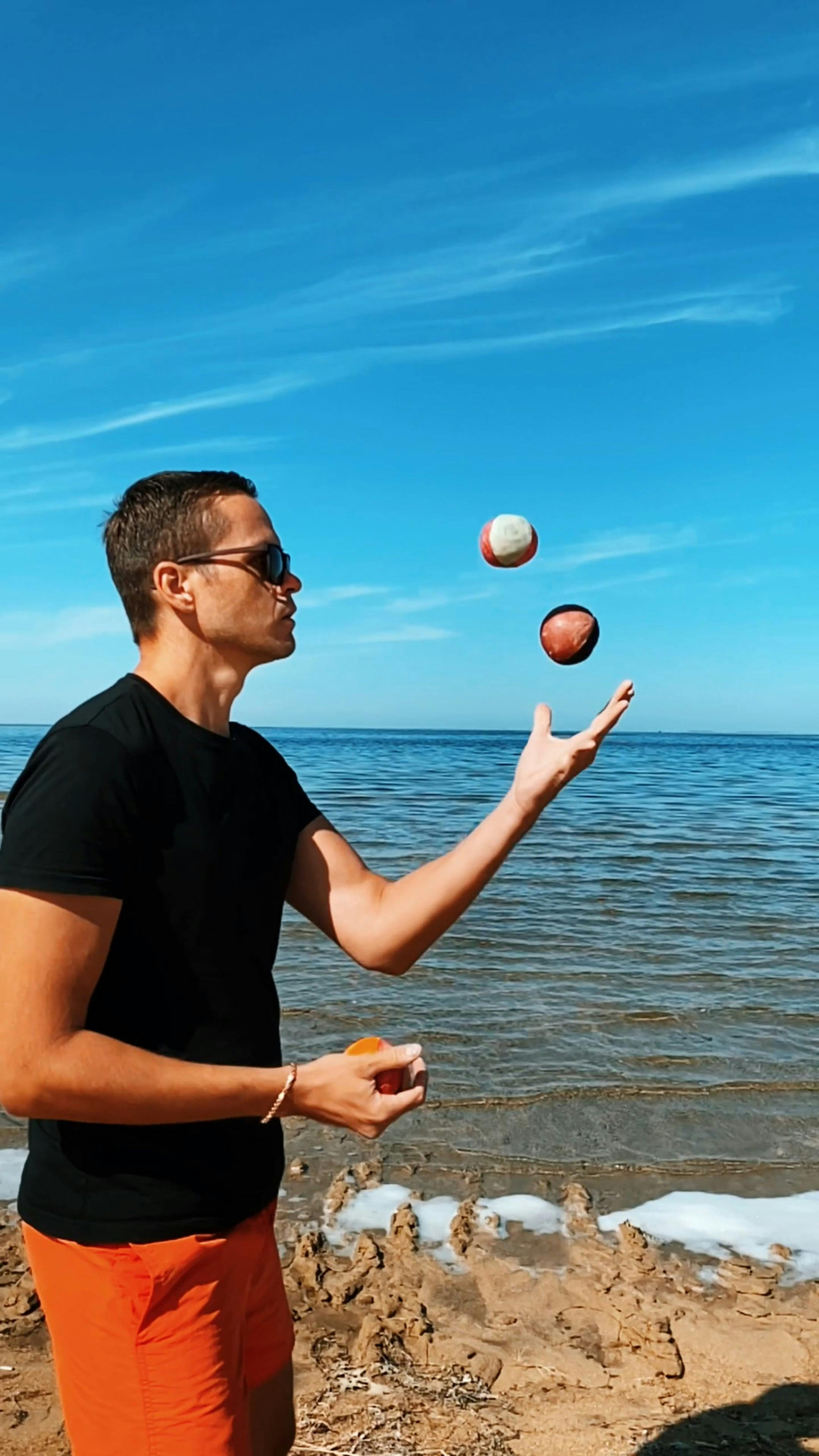Side View of a Young Man Juggling Balls on the Beach Free Stock Video ...
