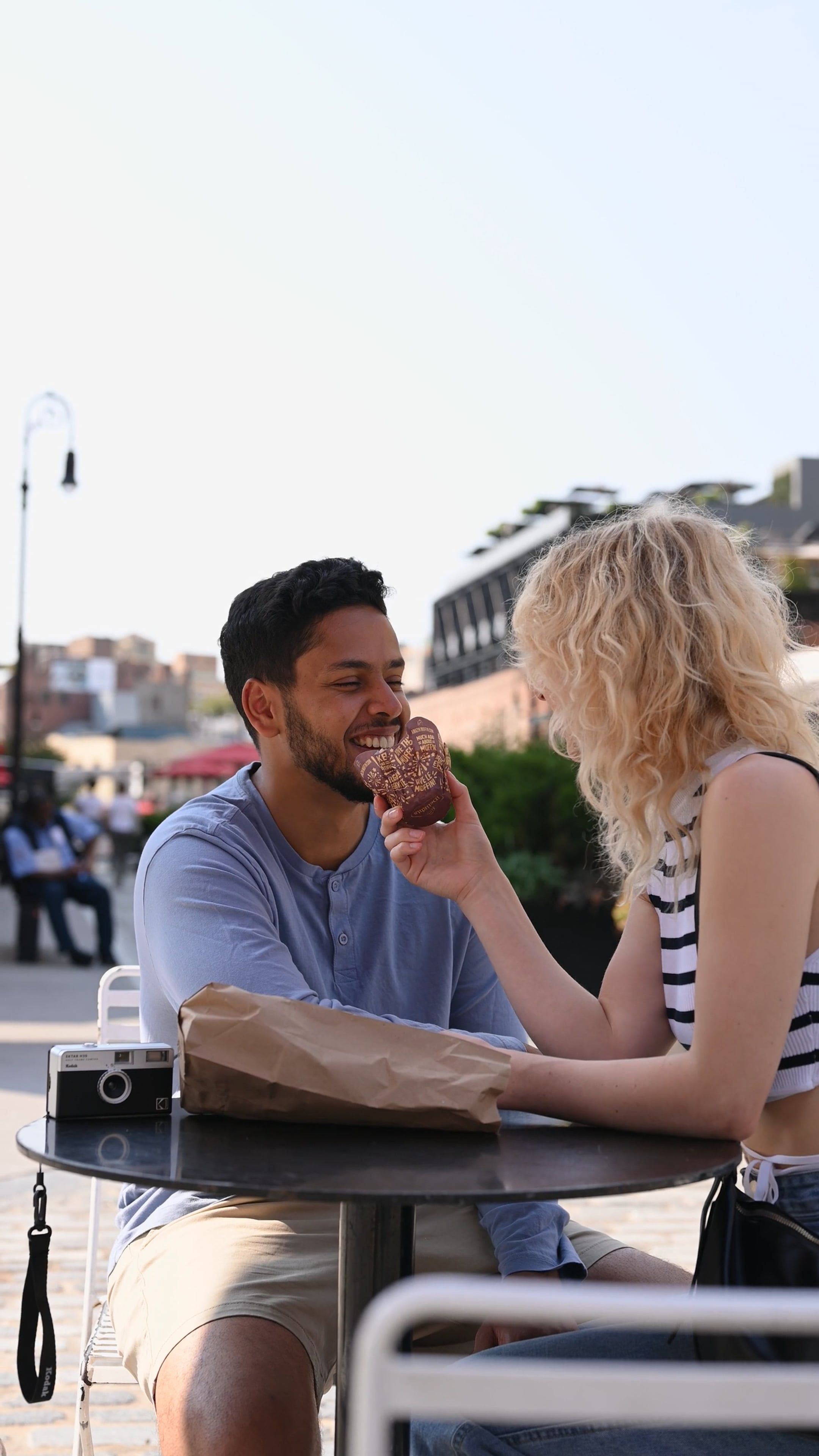 A Happy Couple Sharing a Muffin at an Outdoor Café Free Stock Video ...