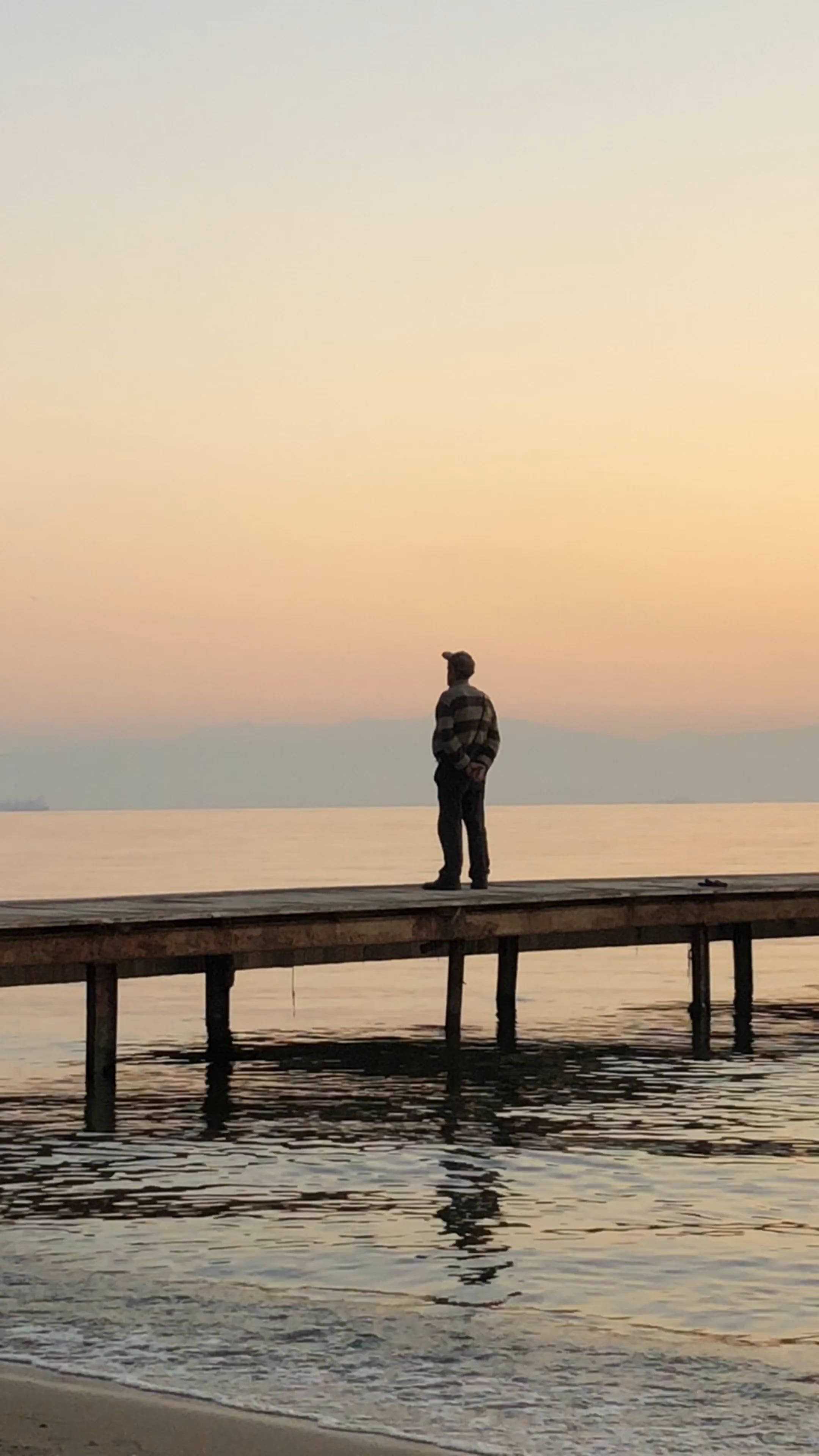A Man Walking on a Pier under a Sunset Sky Free Stock Video Footage ...