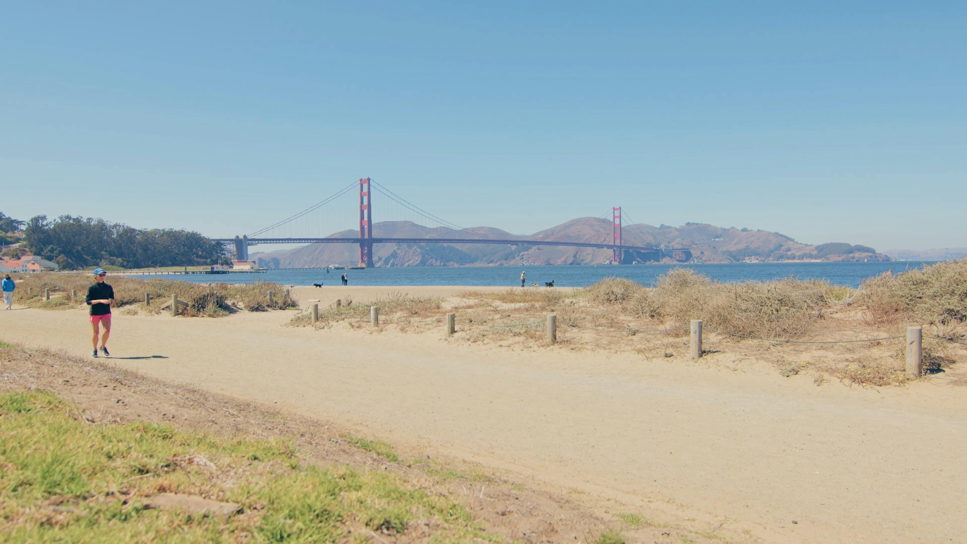 A Woman Jogging by the Golden Gate Beach in San Francisco, California ...