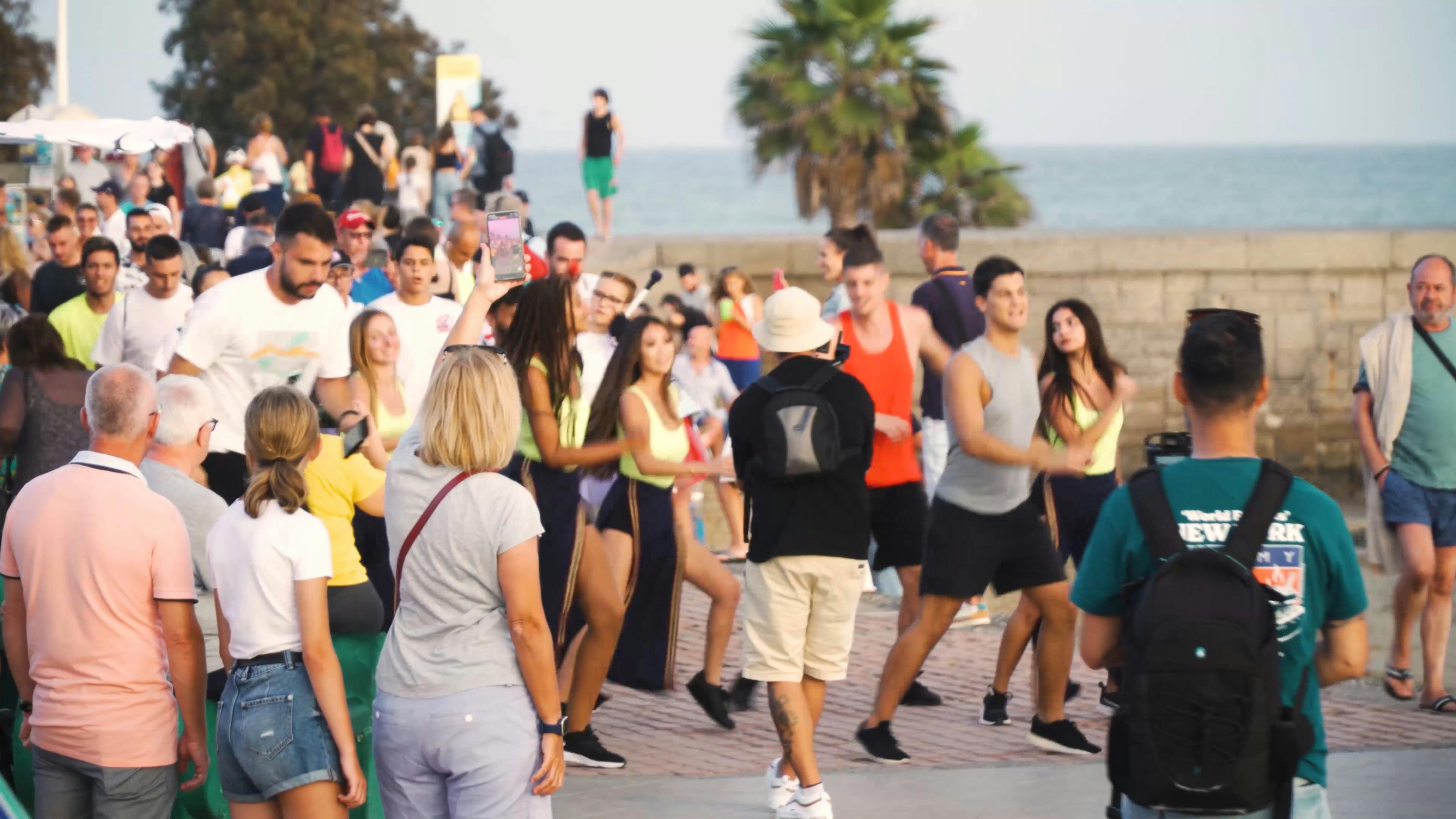 A Group of Dancers and Musicians Performing on a Crowded Promenade Free ...