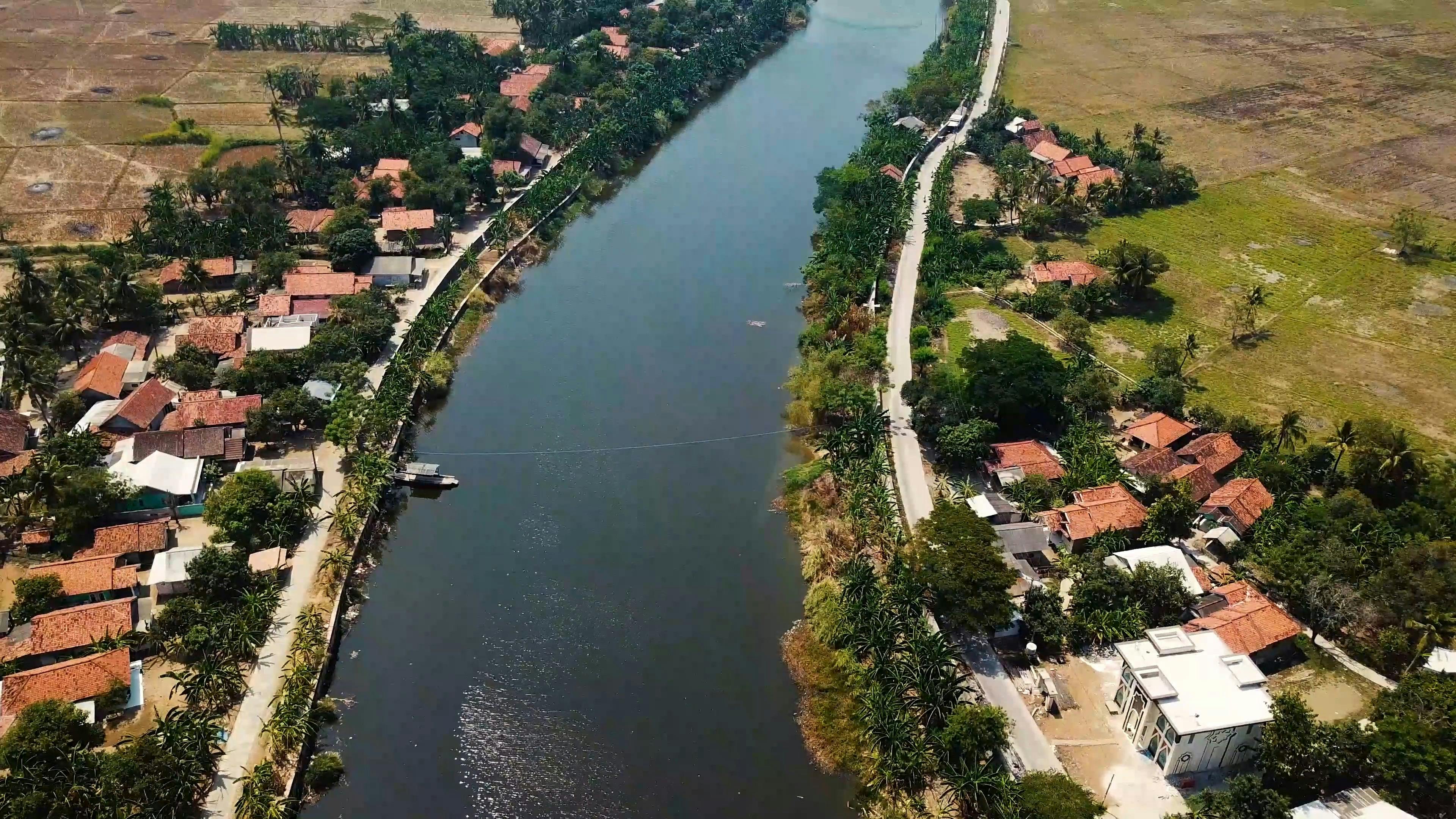 A River Between Two Farmlands · Free Stock Video