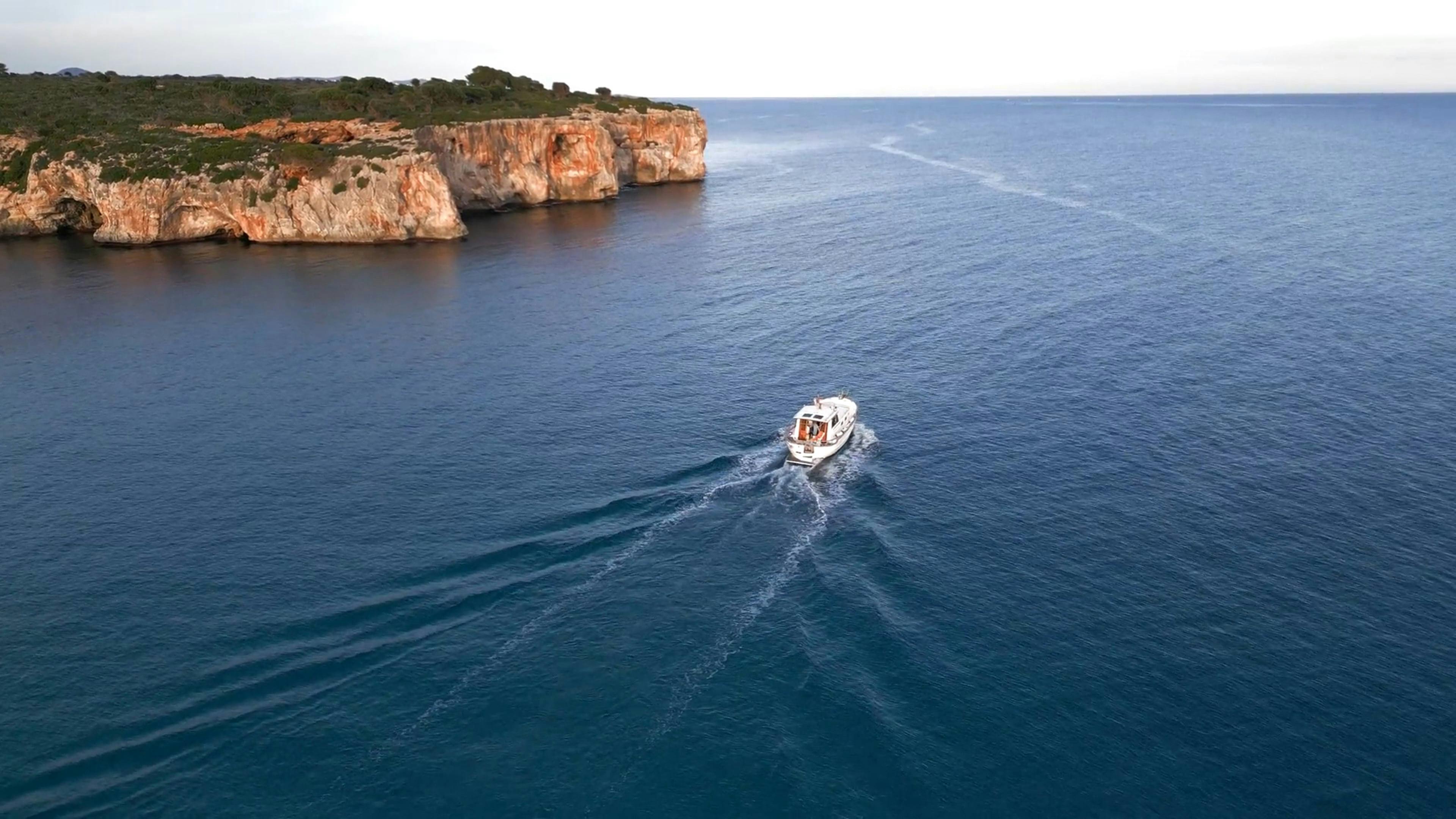 Drone Footage of a Boat Sailing near a Cliffed Coast Free Stock Video ...