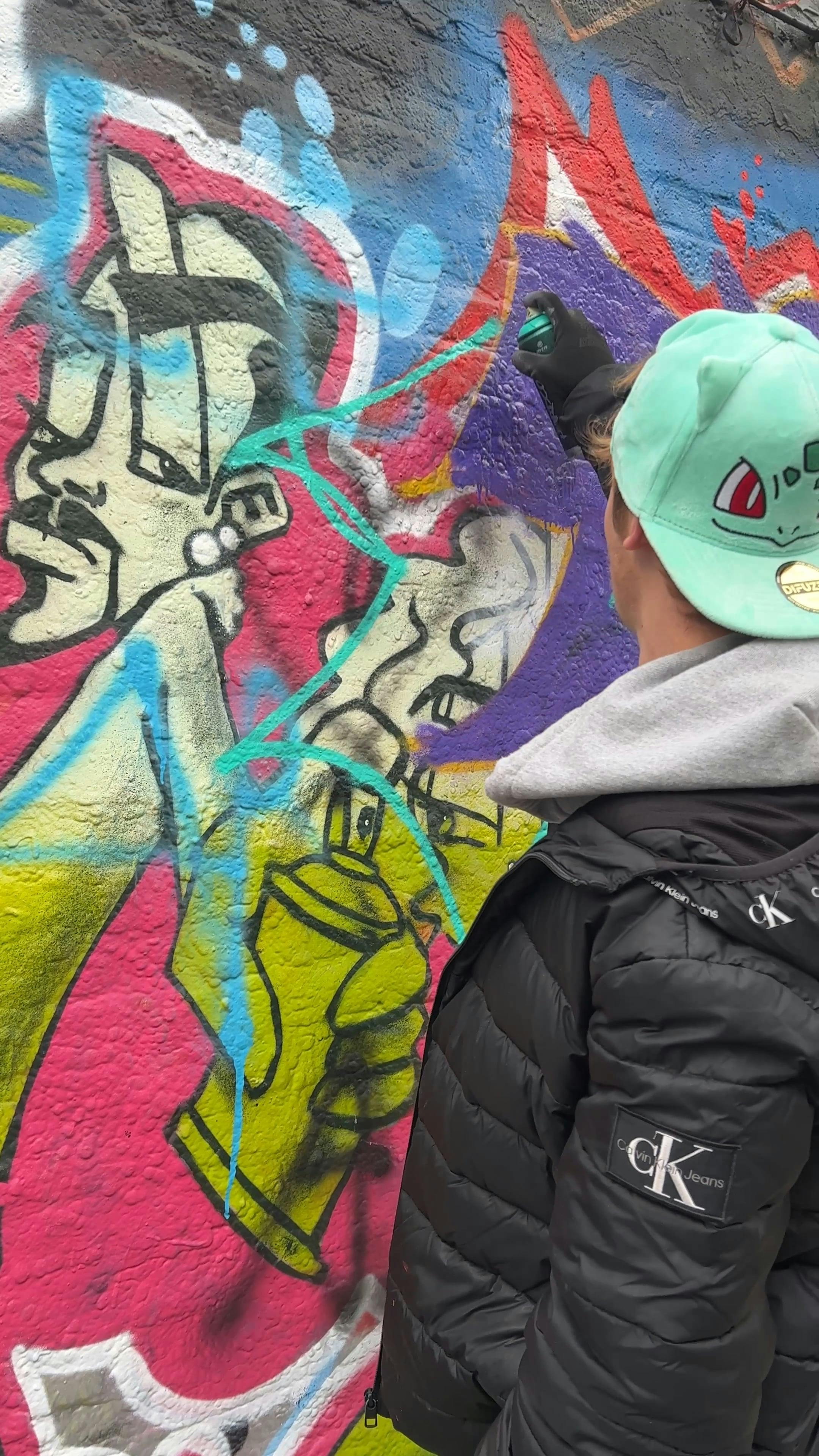 A Graffiti Artist Painting a Colorful Mural Free Stock Video Footage ...